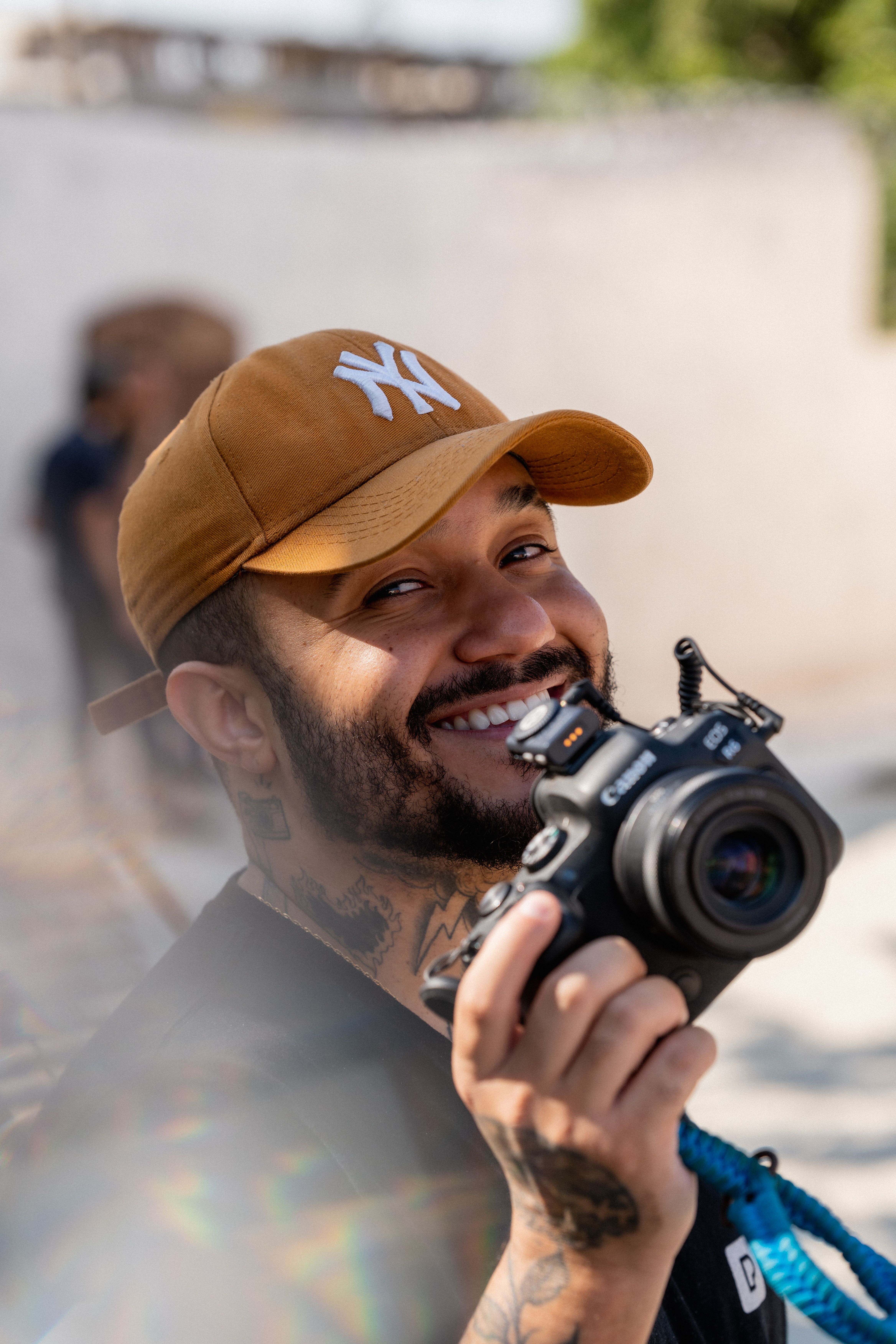 Smiling Photographer Holding a Camera · Free Stock Photo