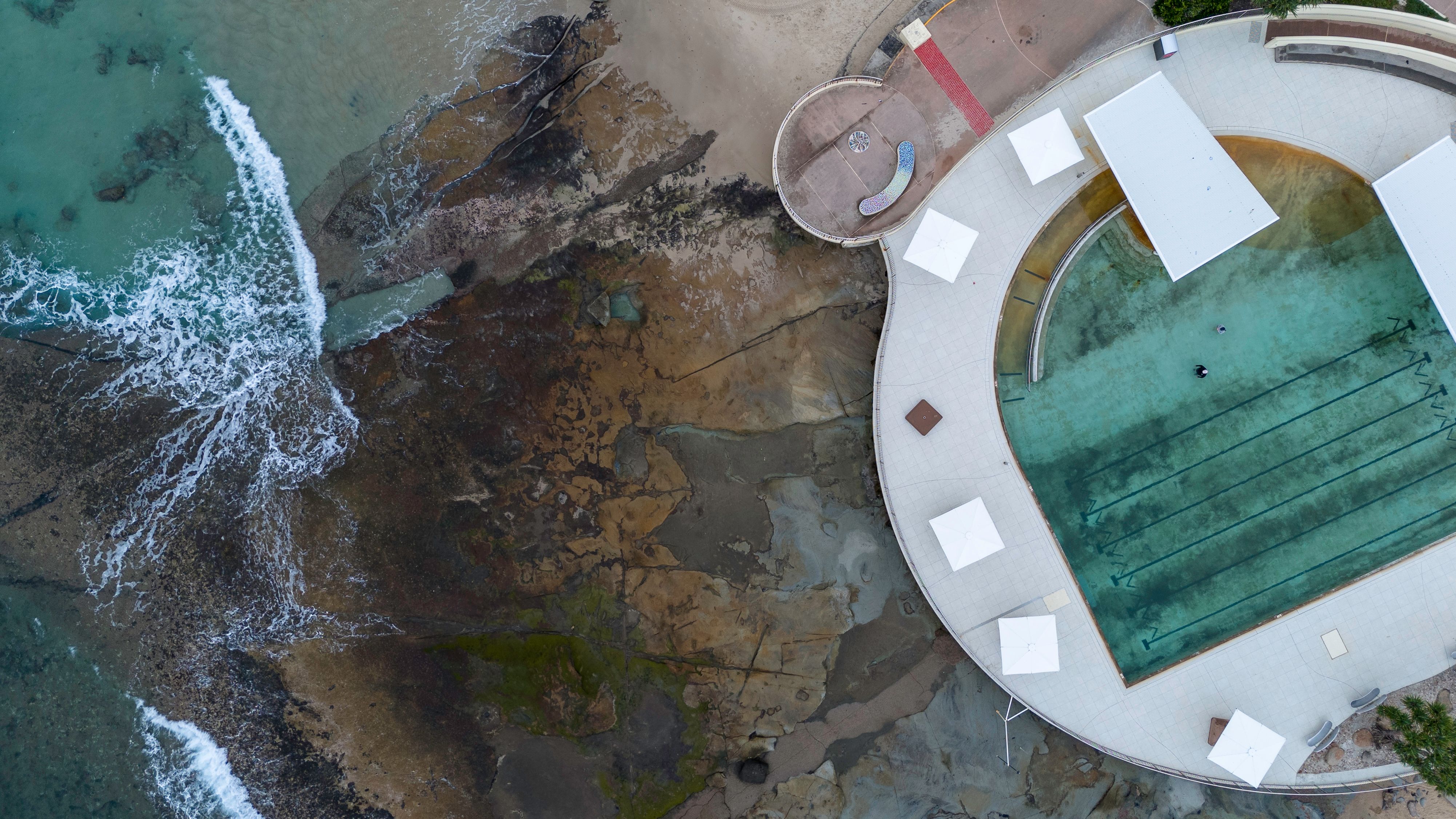 Swimming Pool by the Rocky Shore · Free Stock Photo