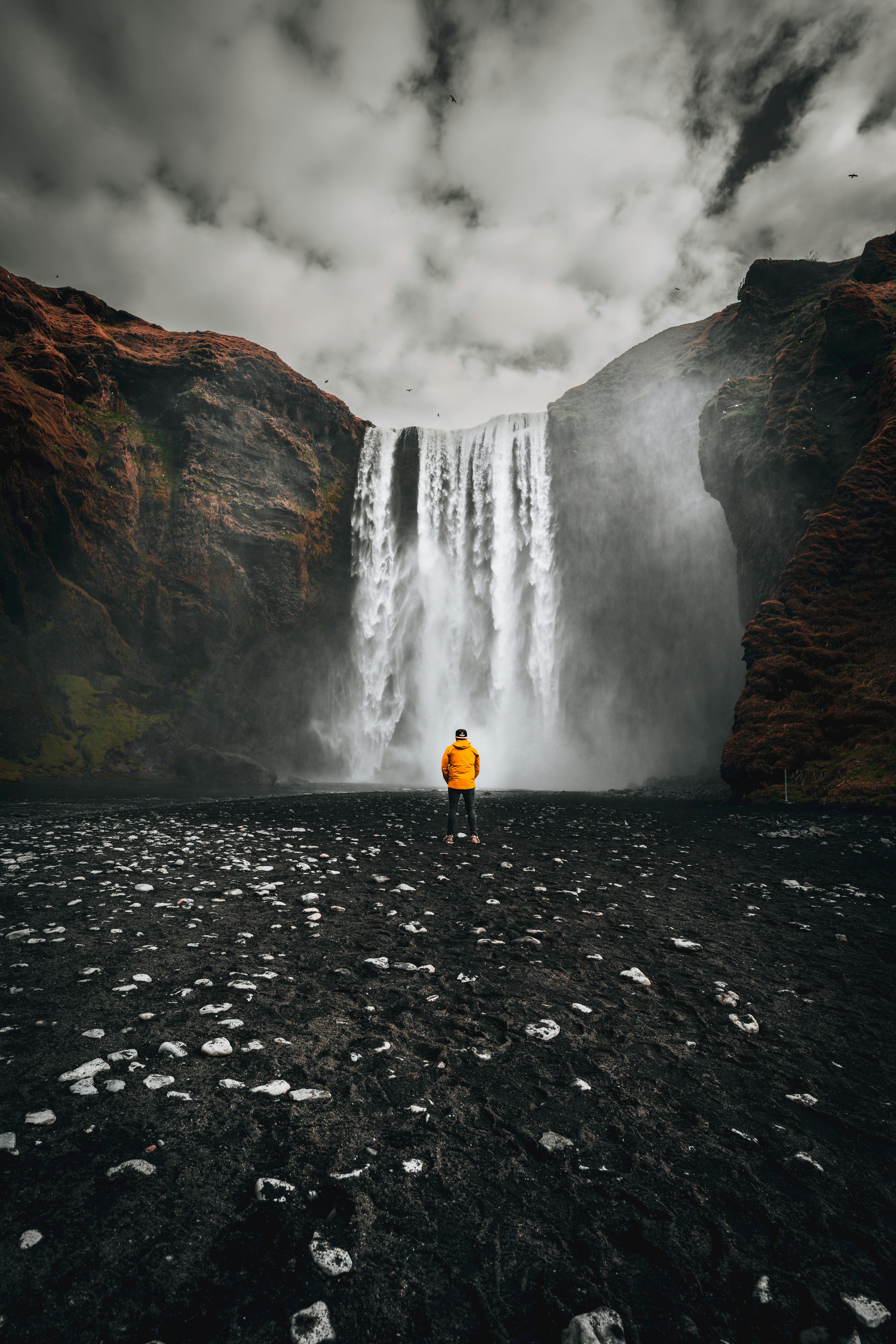 A Person Standing in Front of a Waterfall · Free Stock Photo