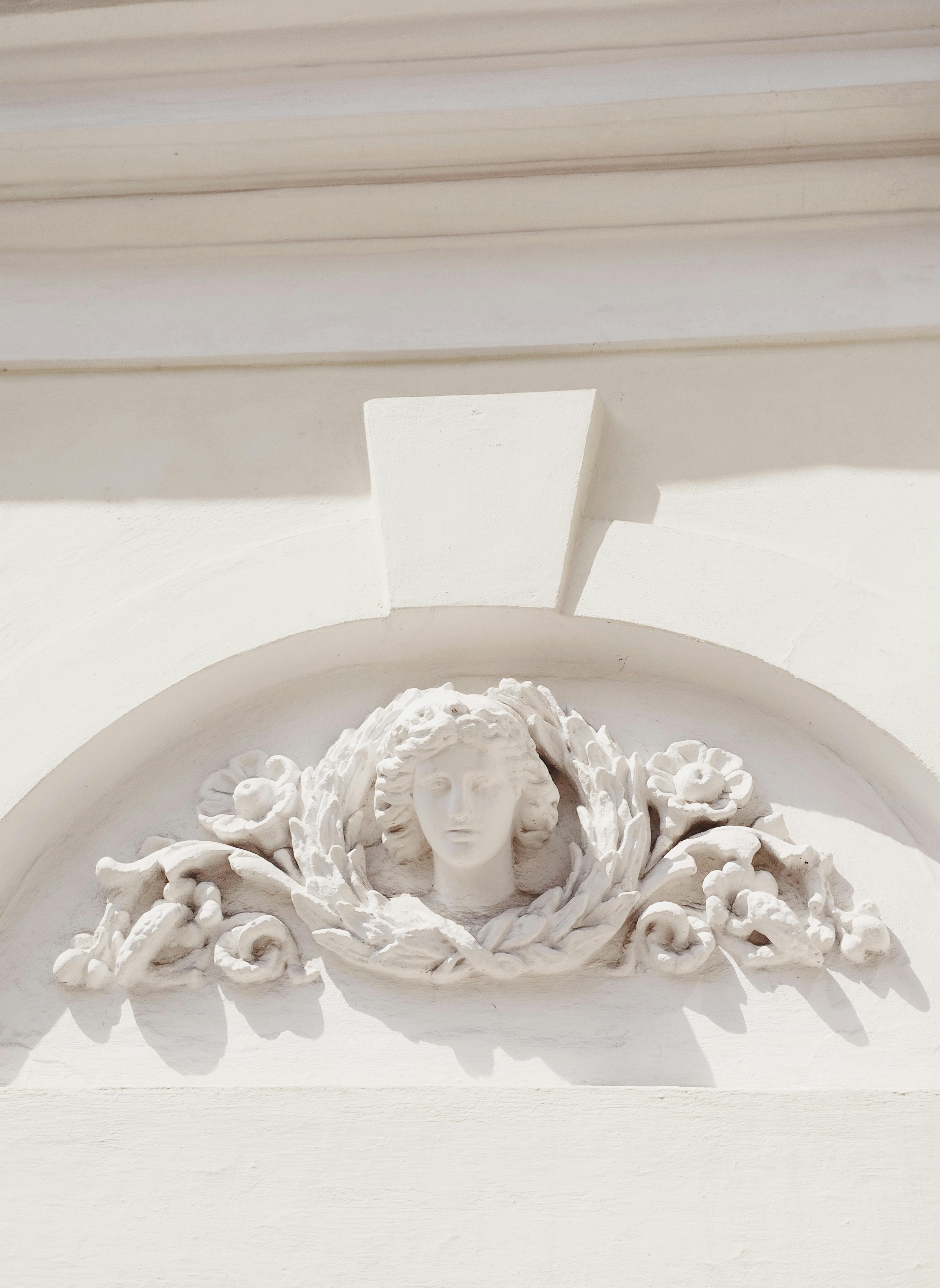 Sculpture on Building Wall · Free Stock Photo