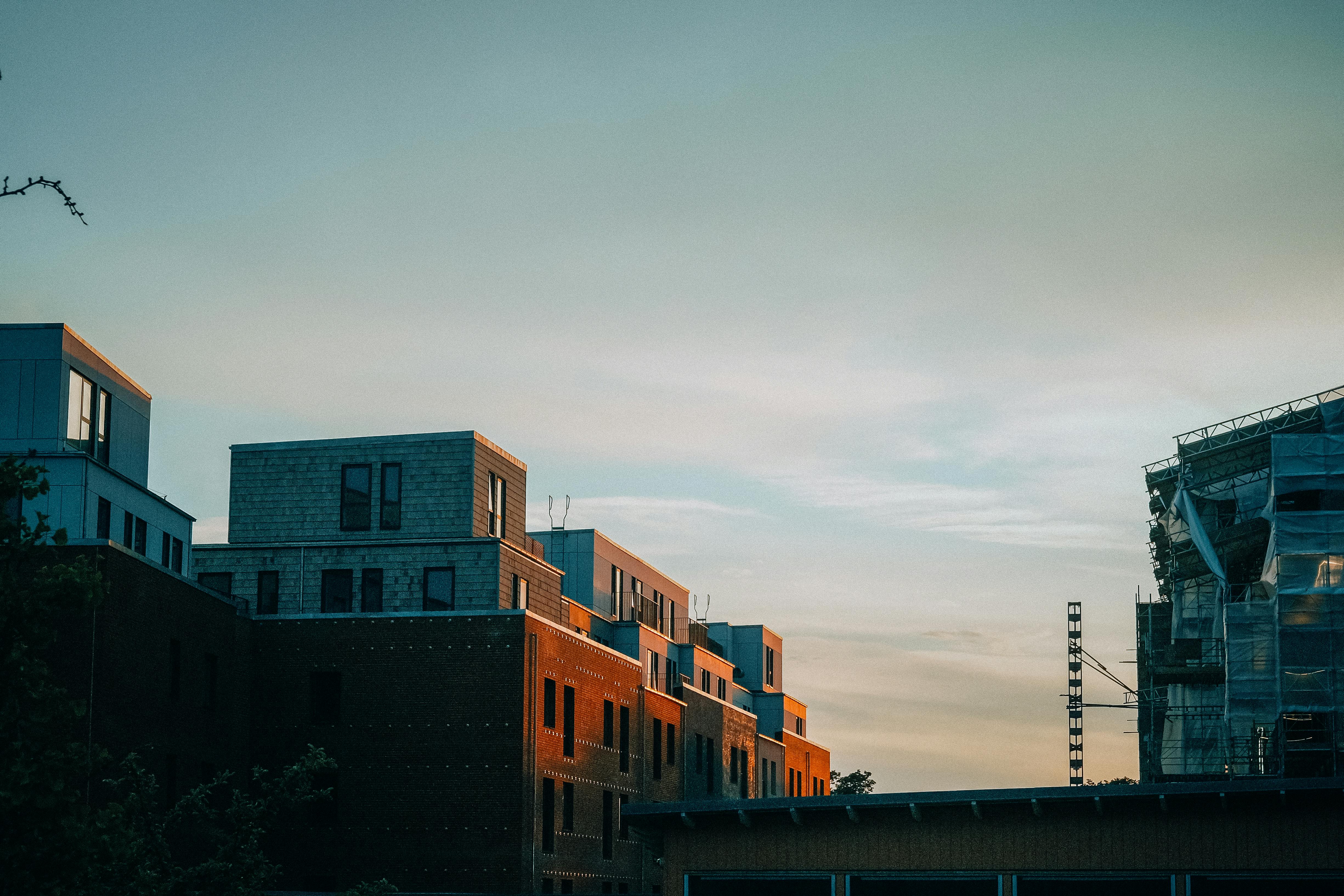 A sunset over buildings in a city · Free Stock Photo