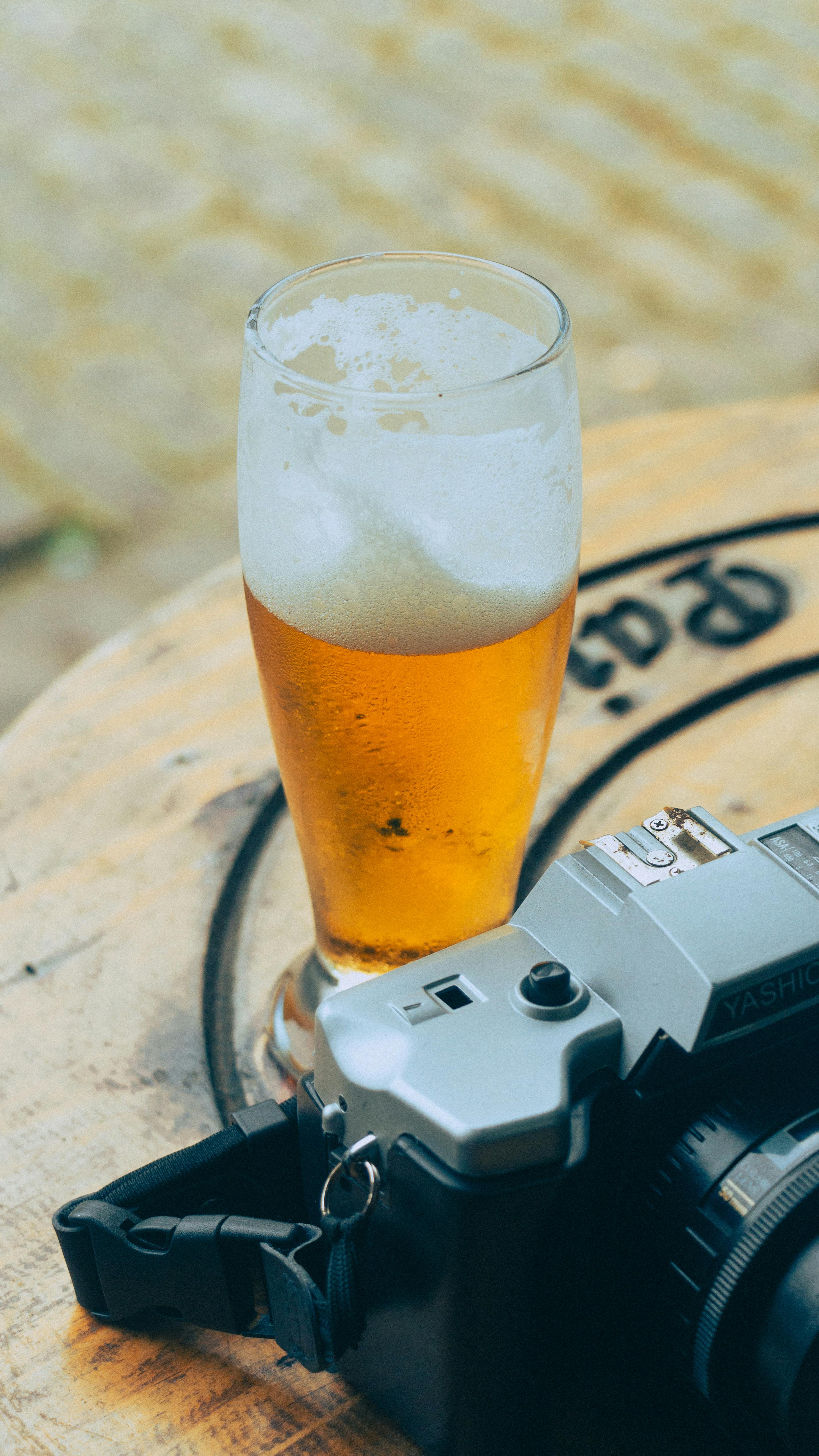 Camera and Glass of Beer · Free Stock Photo
