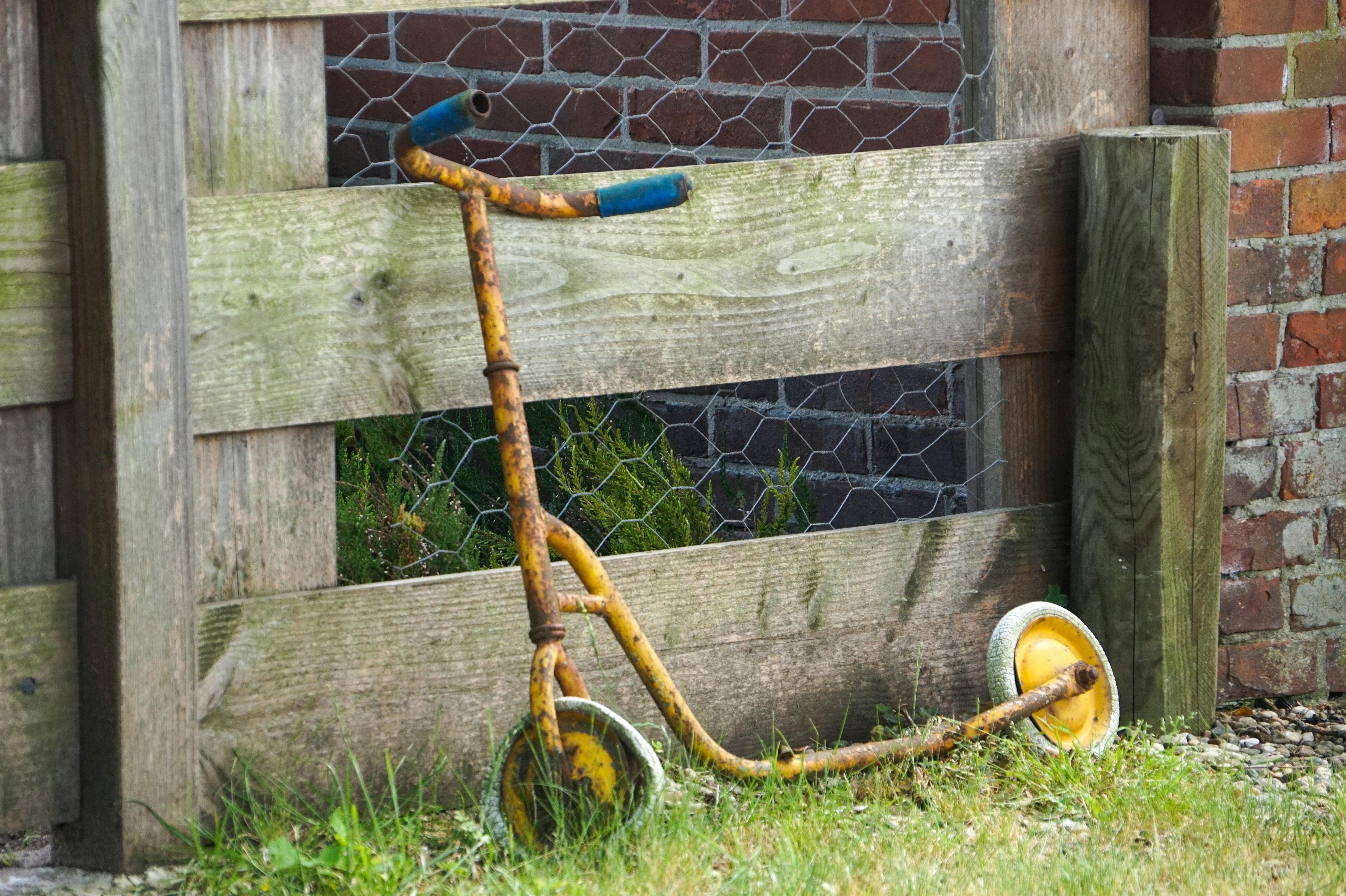 Rusty Scooter on Vintage Fence · Free Stock Photo