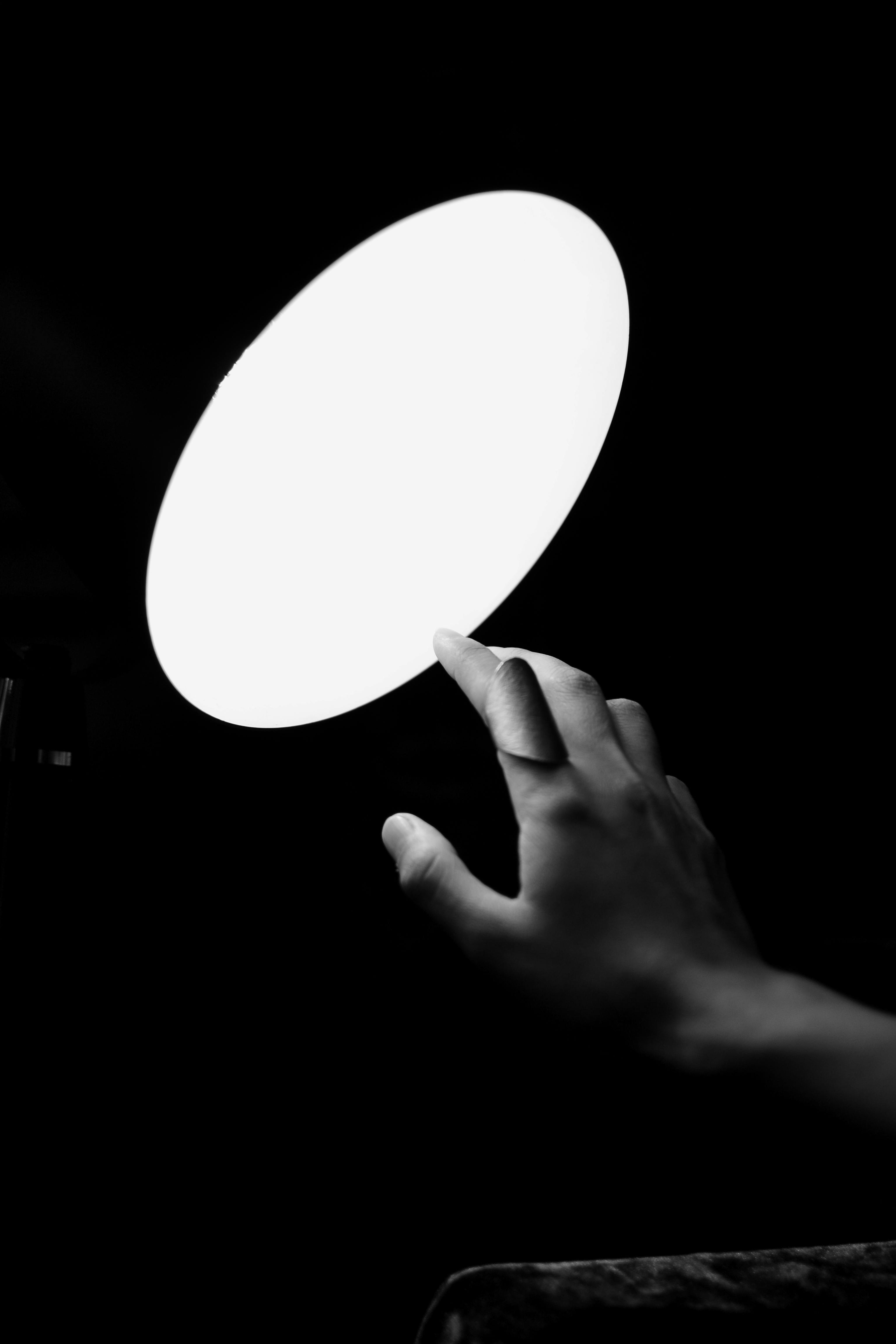 Hand Reaching to Shining Lamp · Free Stock Photo