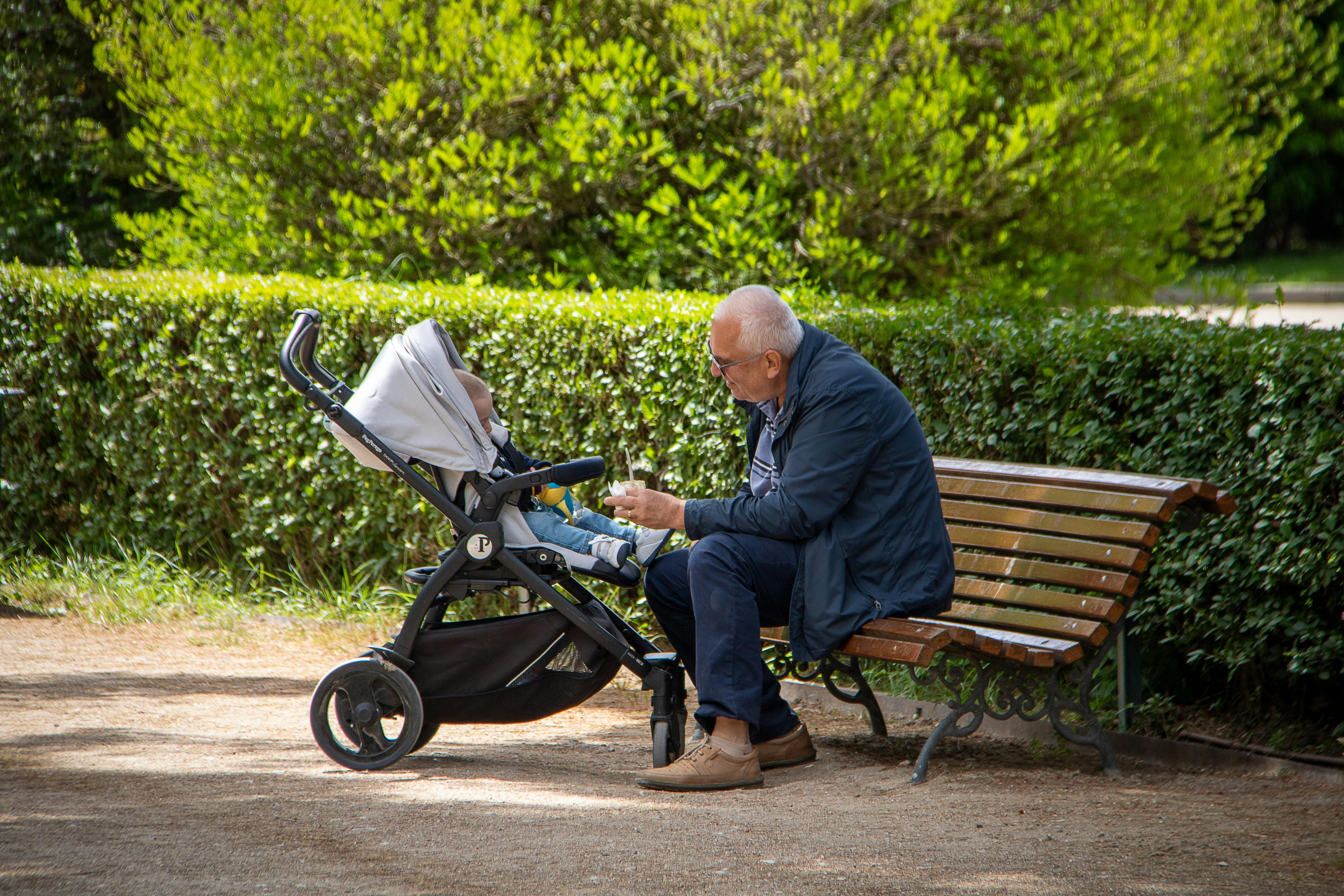 Elderly Man with Stroller on Bench · Free Stock Photo