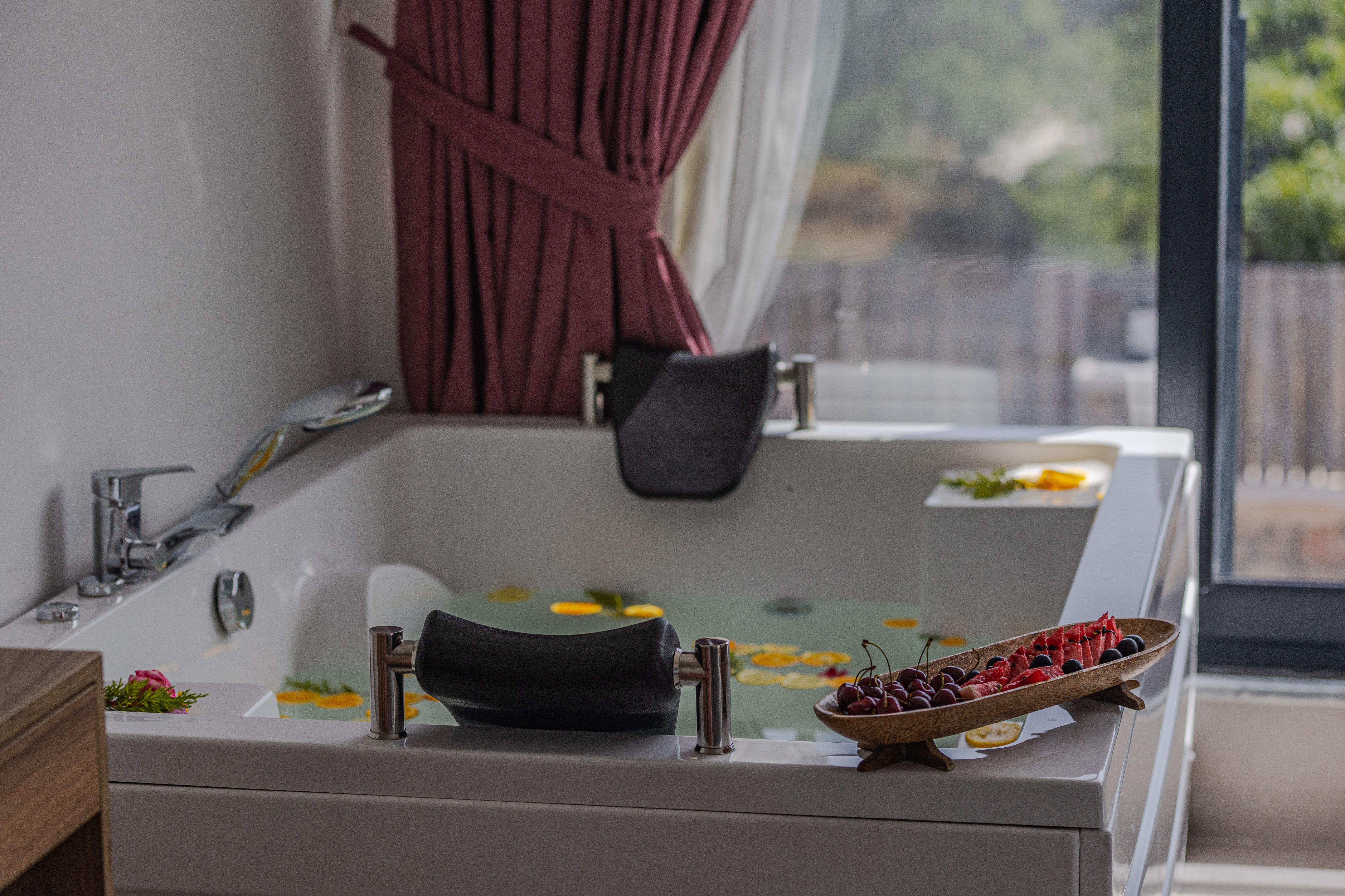 A Relaxing Bath with Floating Petals and a Snack Standing on the Corner ...