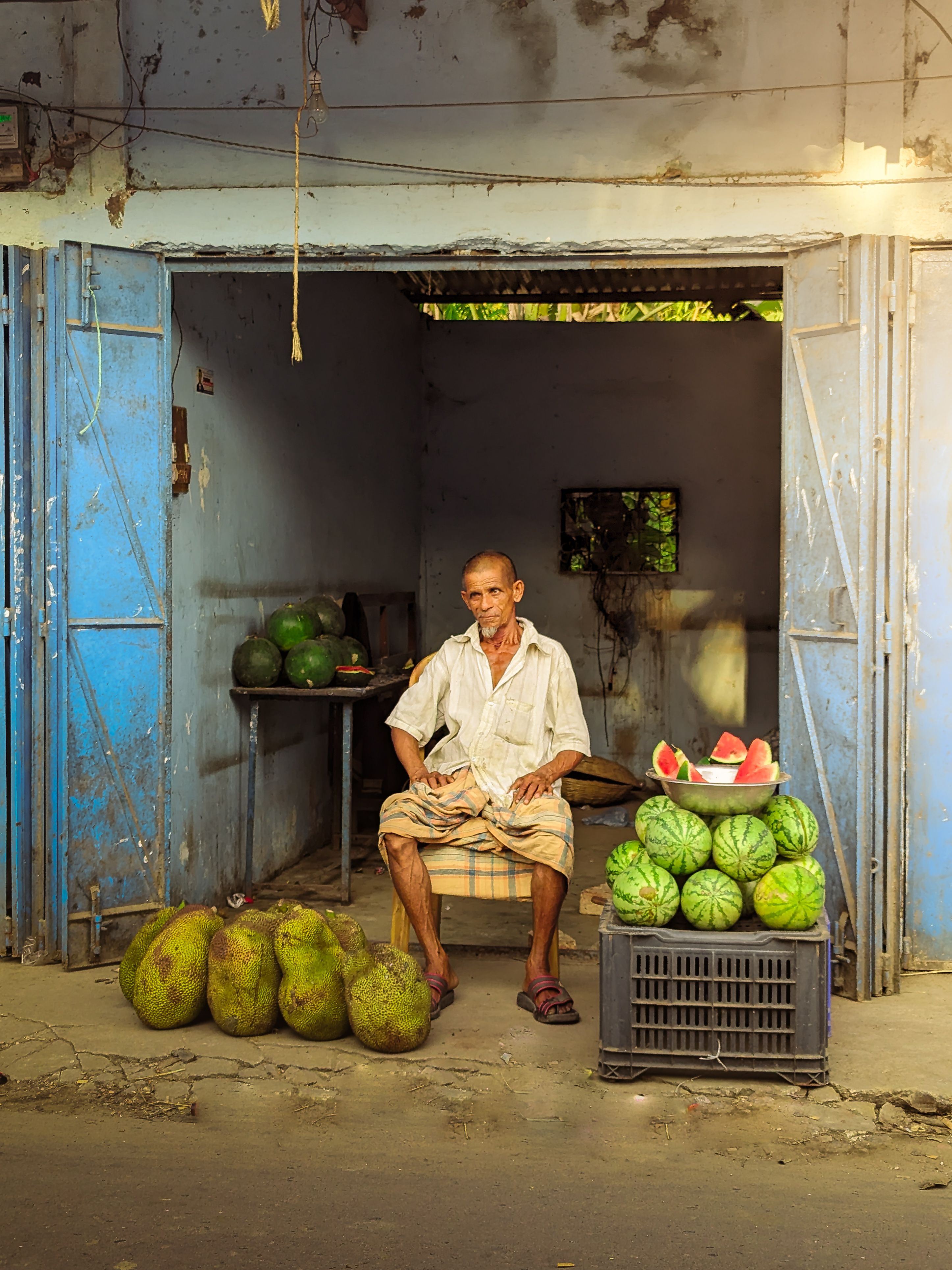 Male Vendor Selling Watermelons and Jackfruits · Free Stock Photo