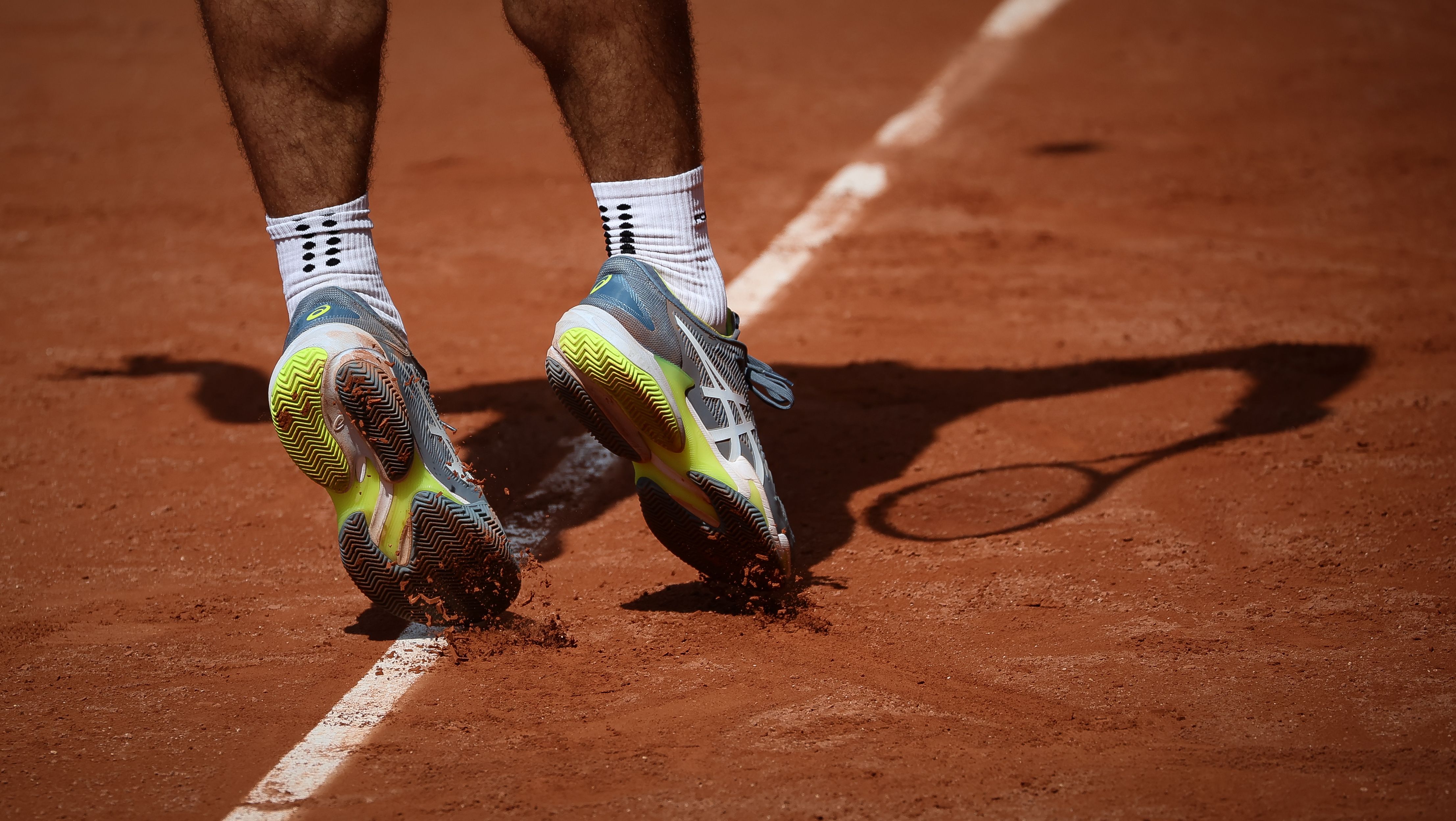 Legs of a Male Tennis Player Serving the Ball · Free Stock Photo