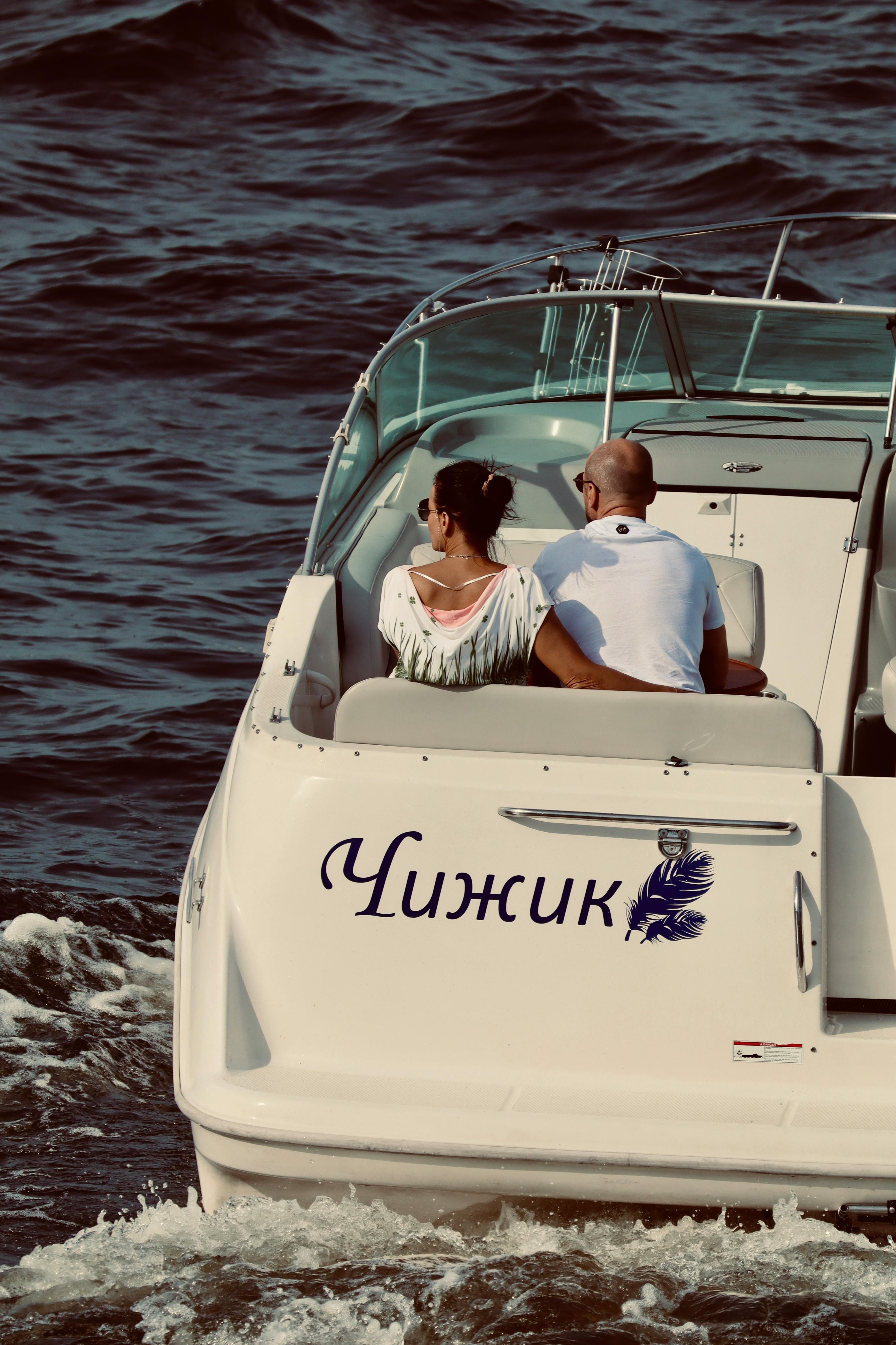 Back View of Couple Sailing on Motorboat · Free Stock Photo