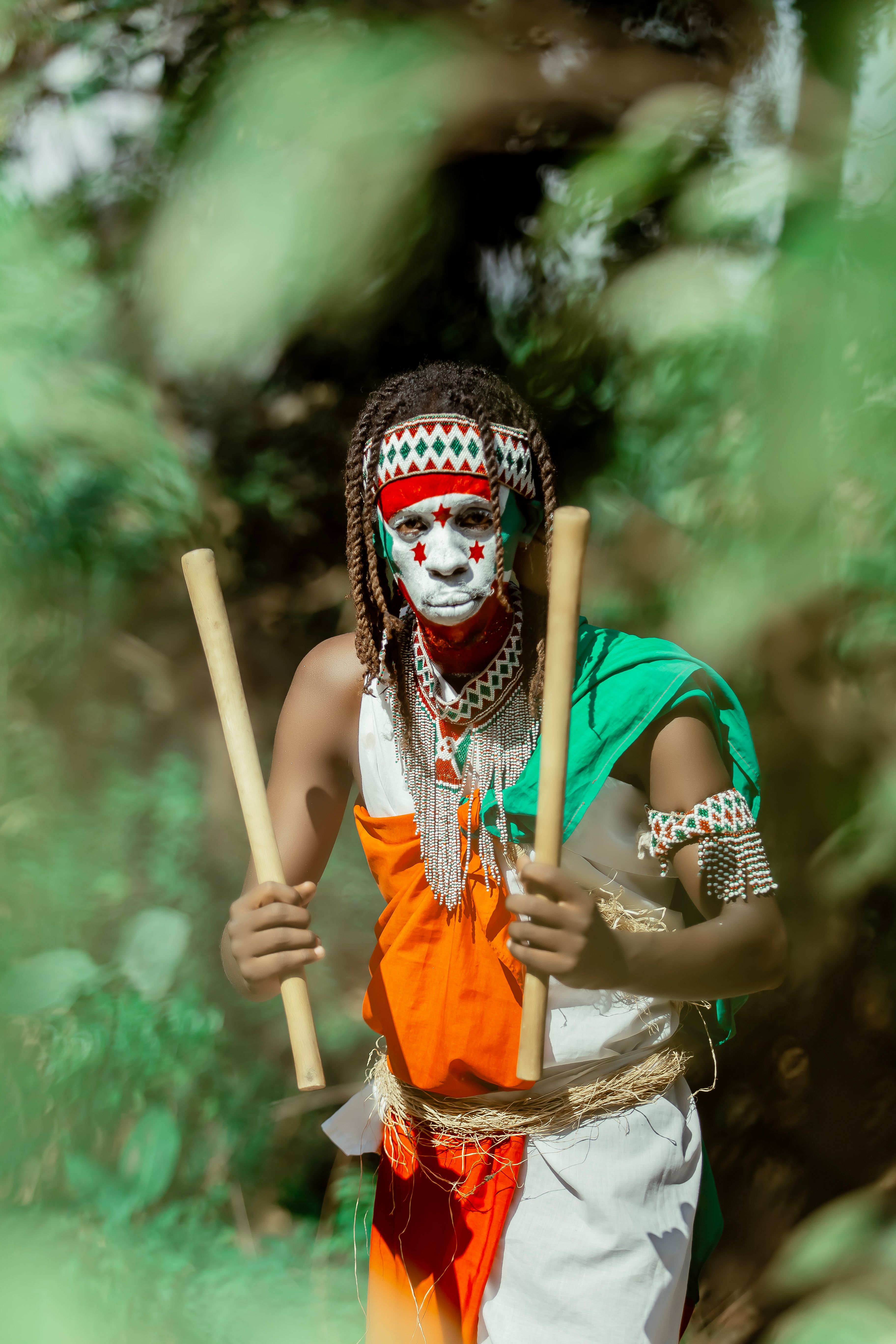 A Man in a Costume and Body Painting Resembling the Flag of Burundi ...