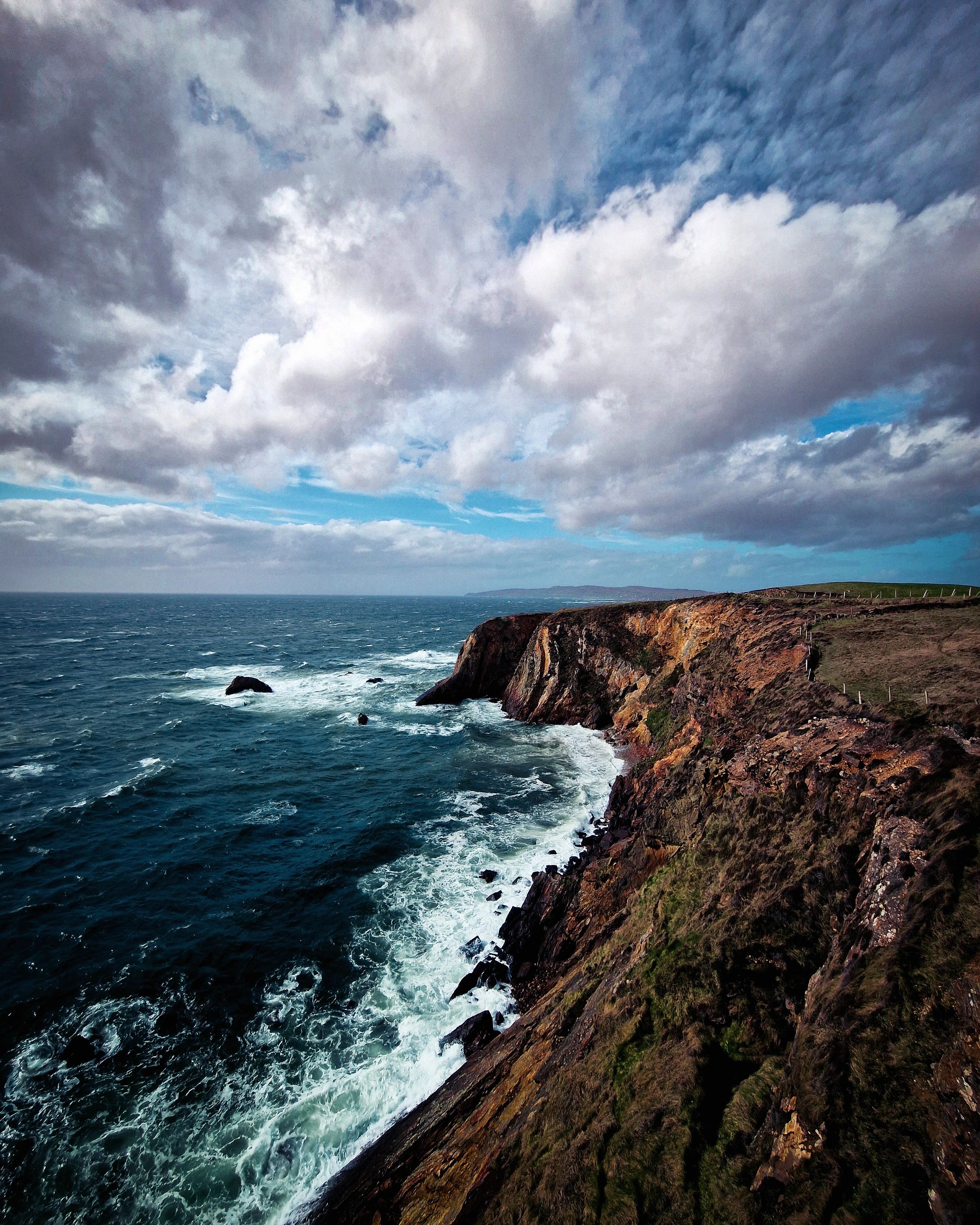 Aerial View of Waves Crashing on a Rocky Cliff · Free Stock Photo