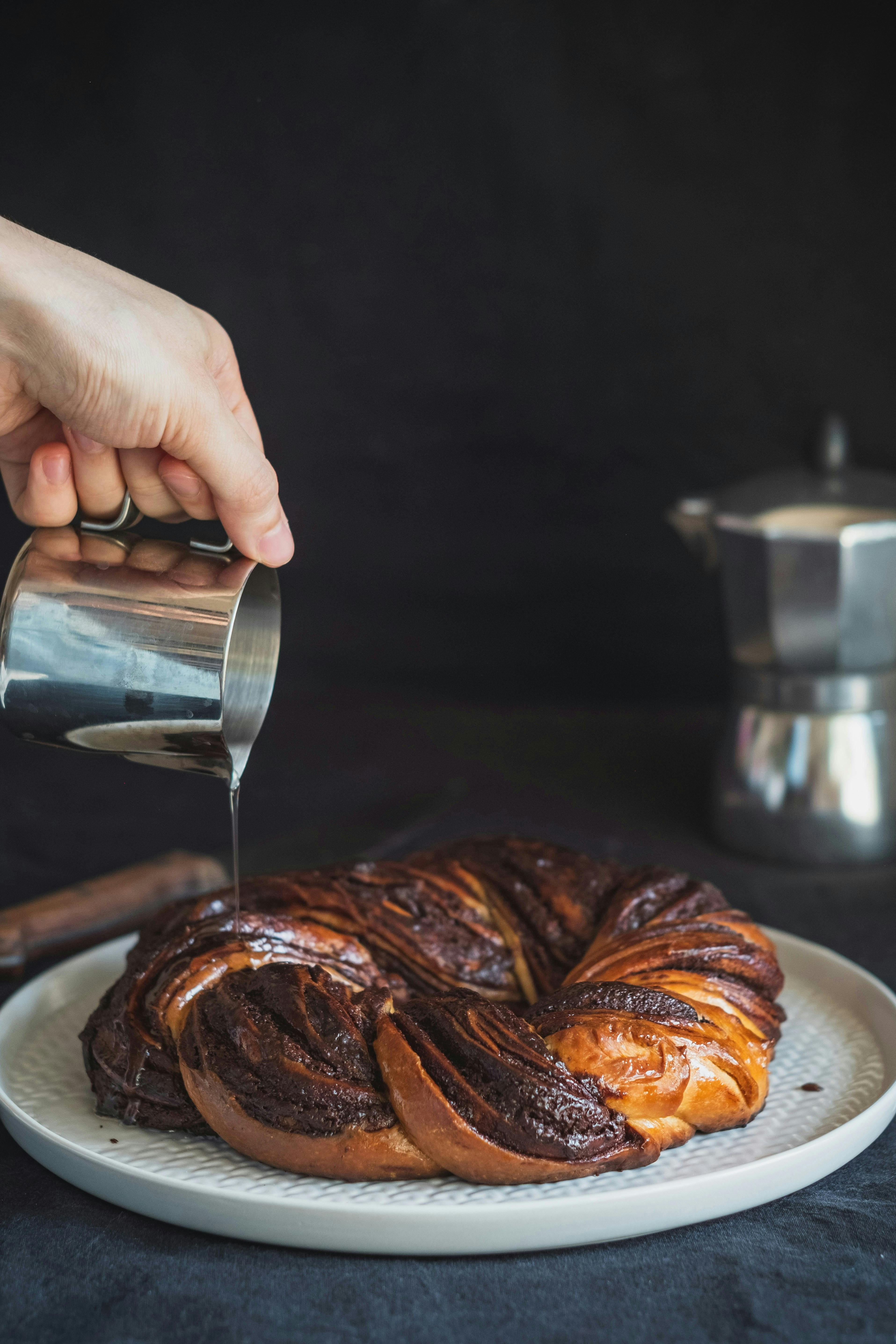 Hand Holding Pitcher over Fresh Baking · Free Stock Photo