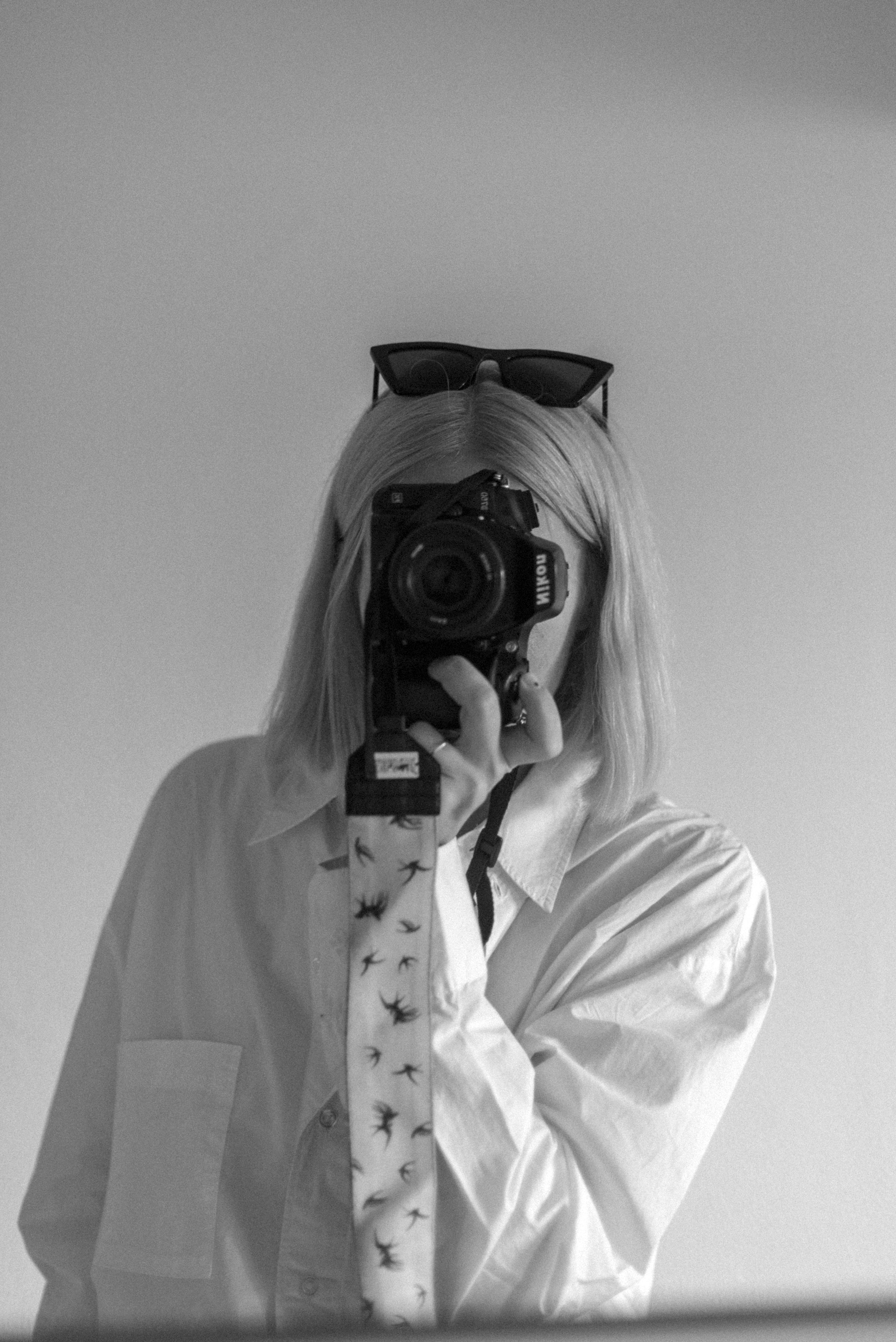 Woman Taking a Photo in Mirror in Black and White · Free Stock Photo