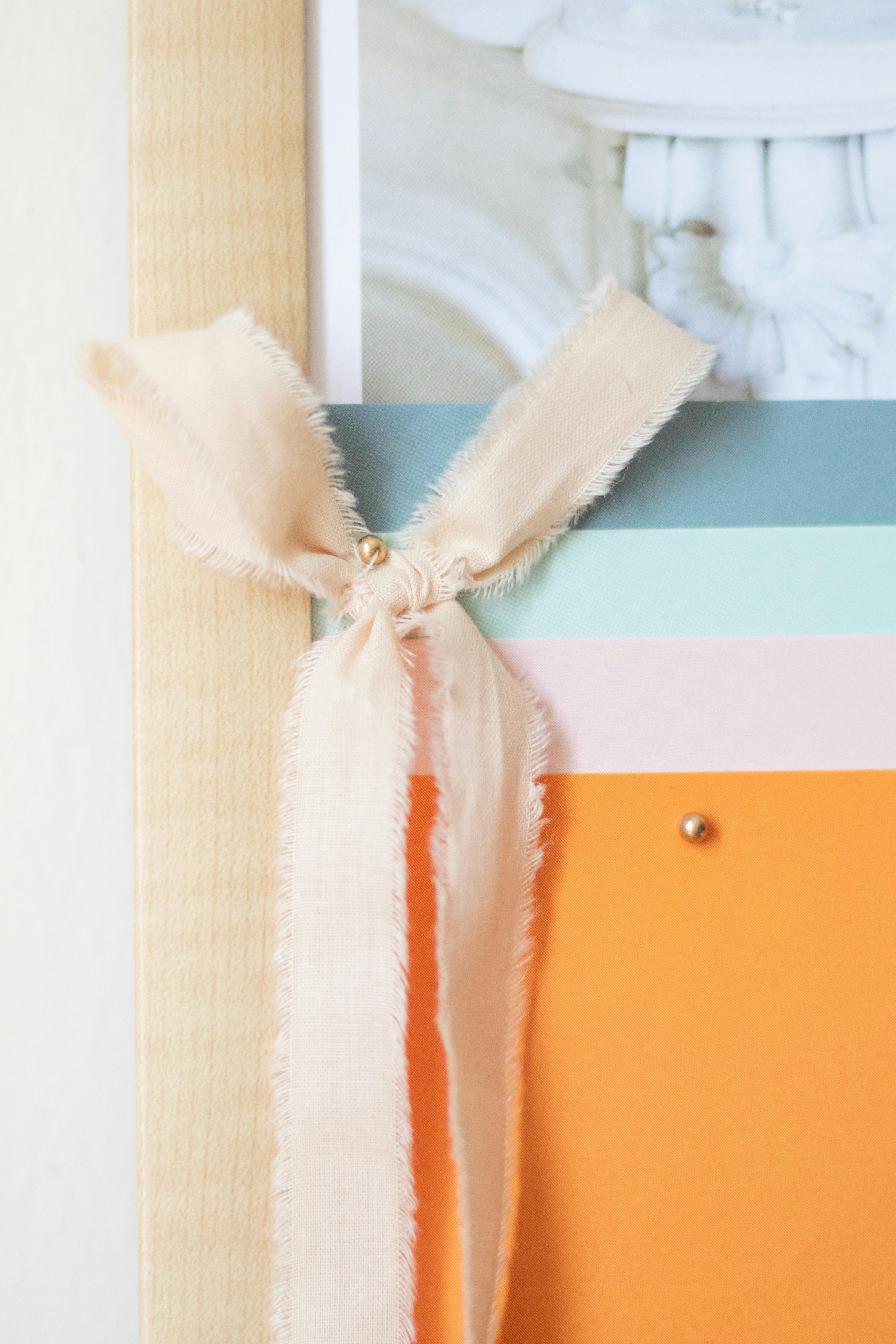 A ribbon tied to a picture frame with a colorful background · Free ...