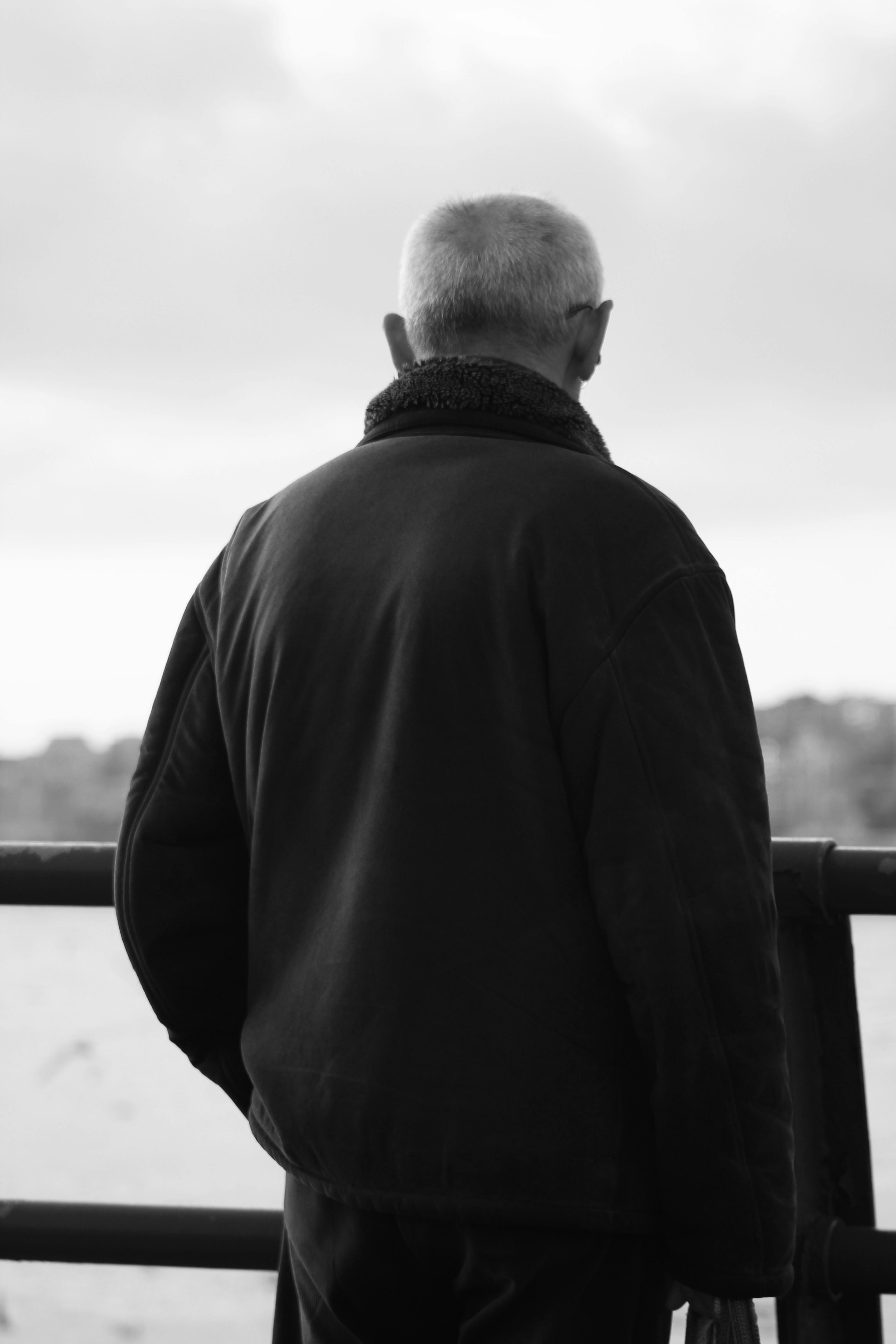 Back View of Elderly Man Standing near Railing · Free Stock Photo