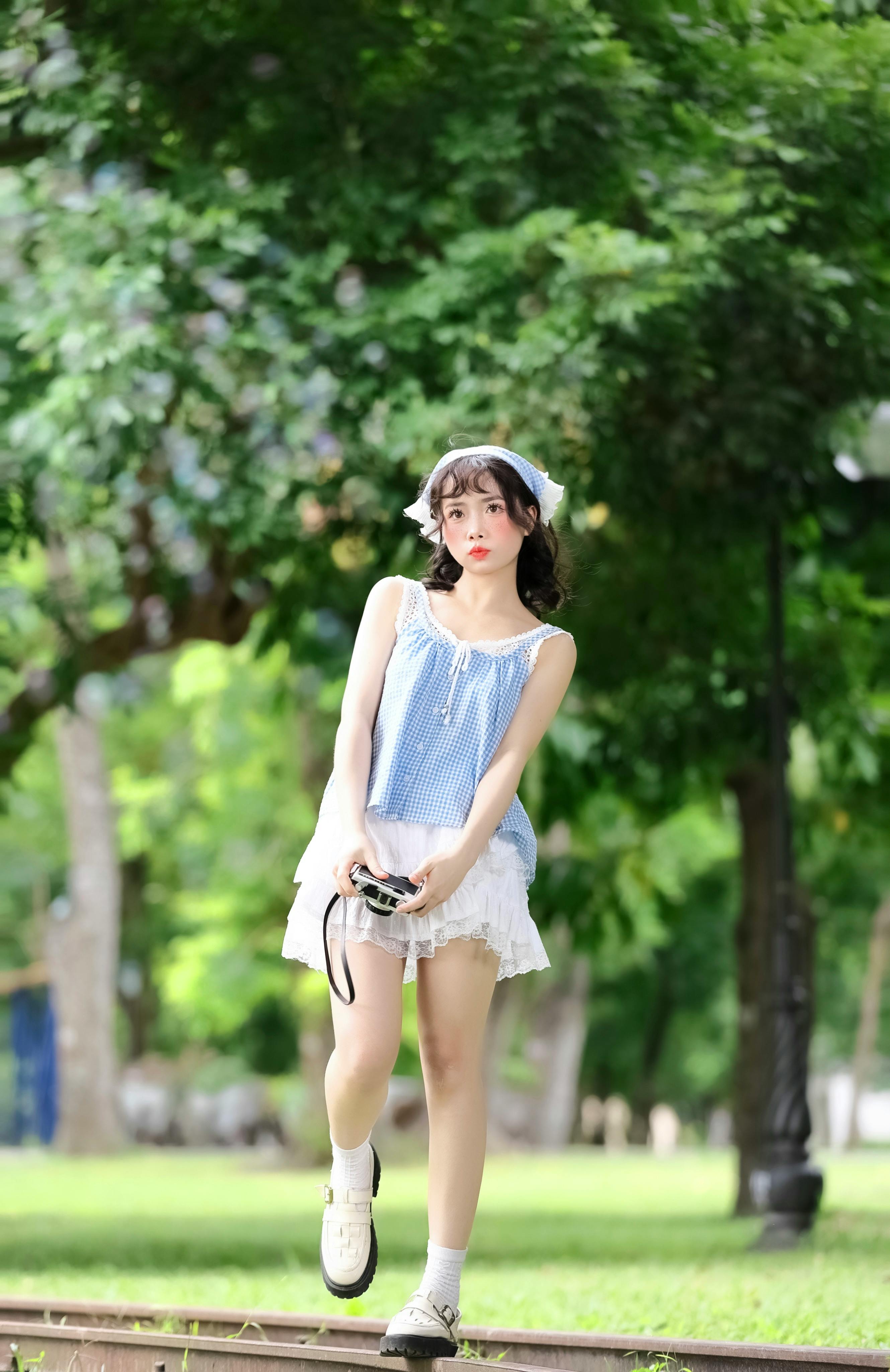 Girl Standing with Camera at Park · Free Stock Photo