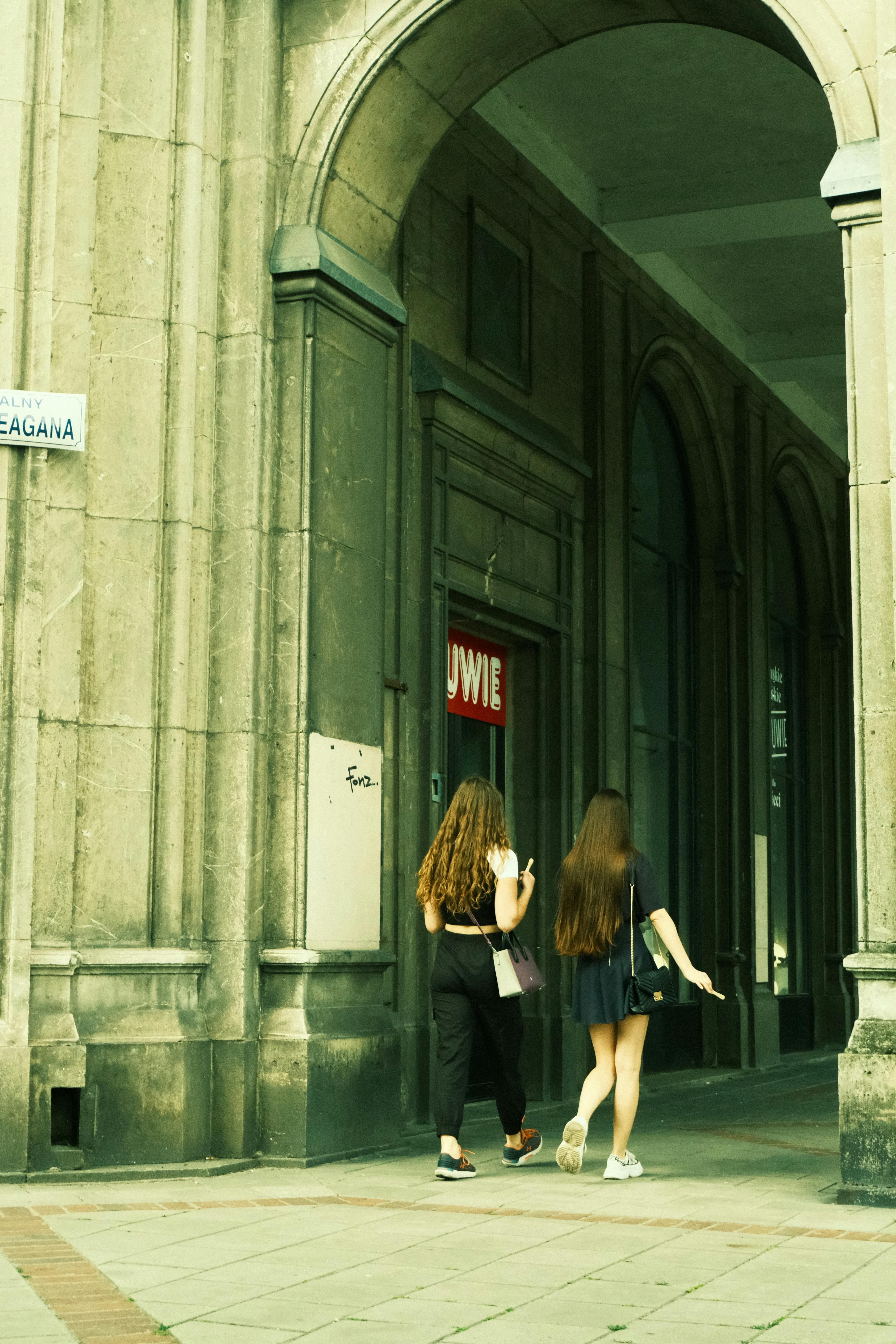 Girl Walking into Passageway · Free Stock Photo