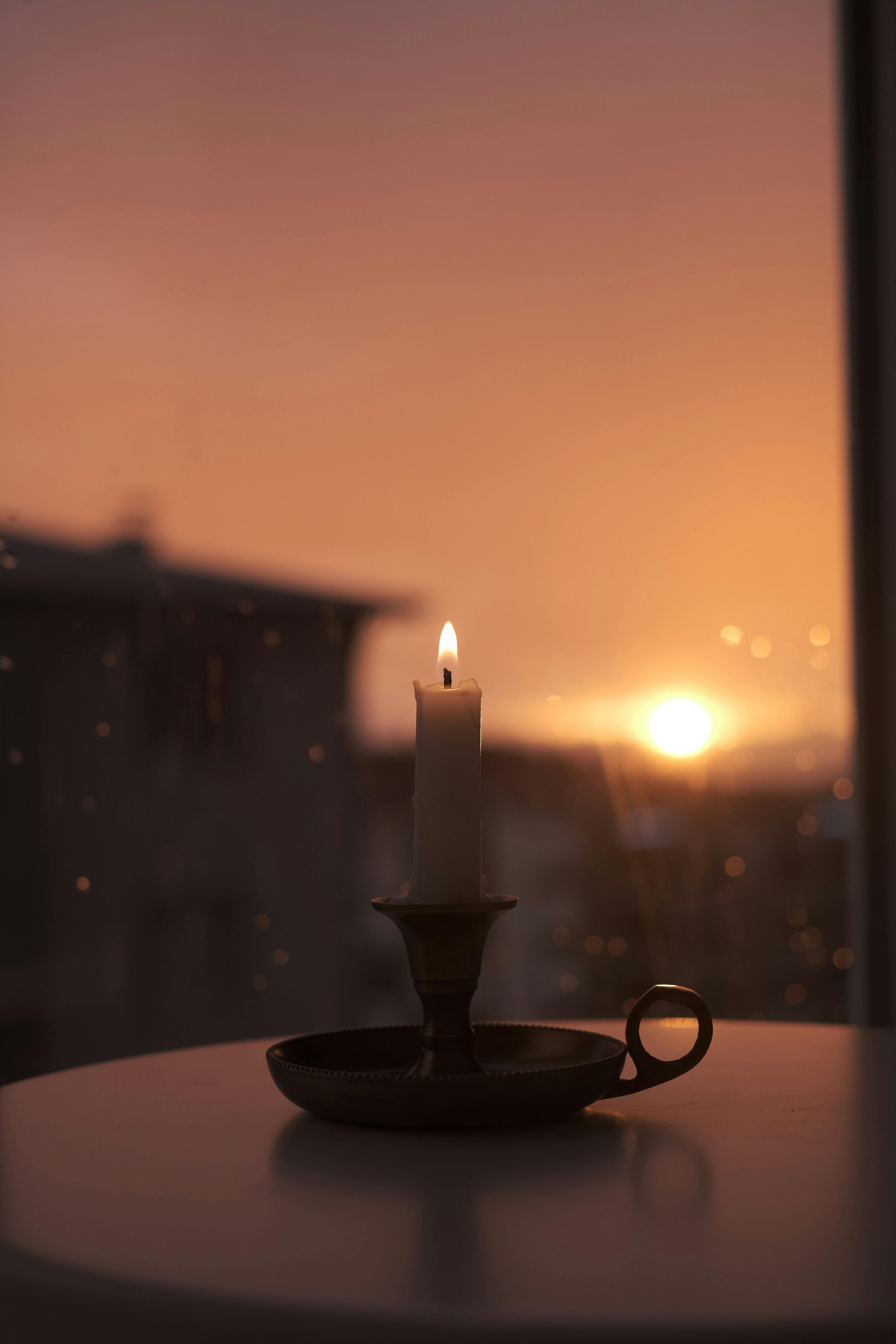 Burning Wax Candle at Sunset · Free Stock Photo