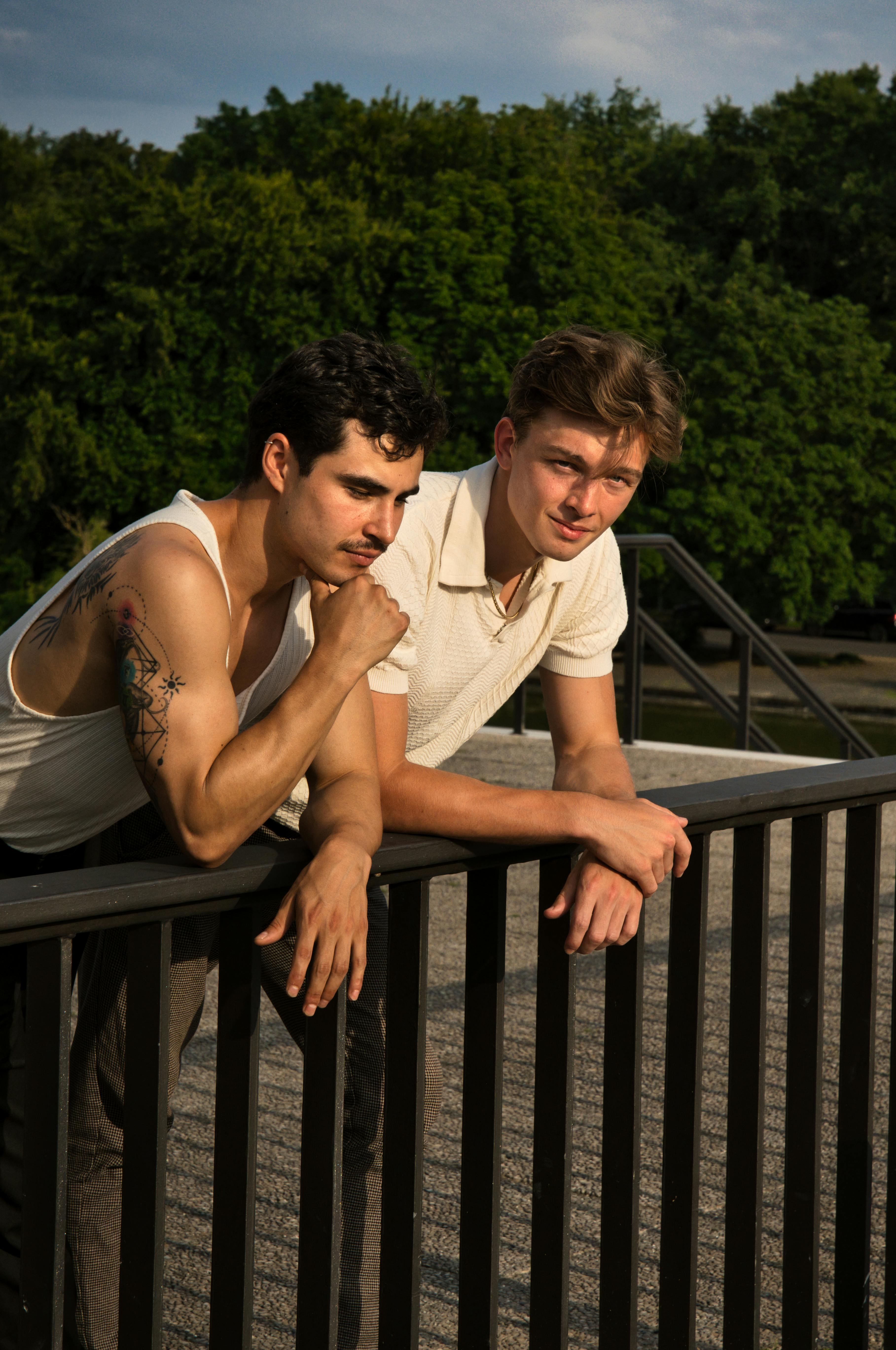 Two Men Leaning on the Railing · Free Stock Photo