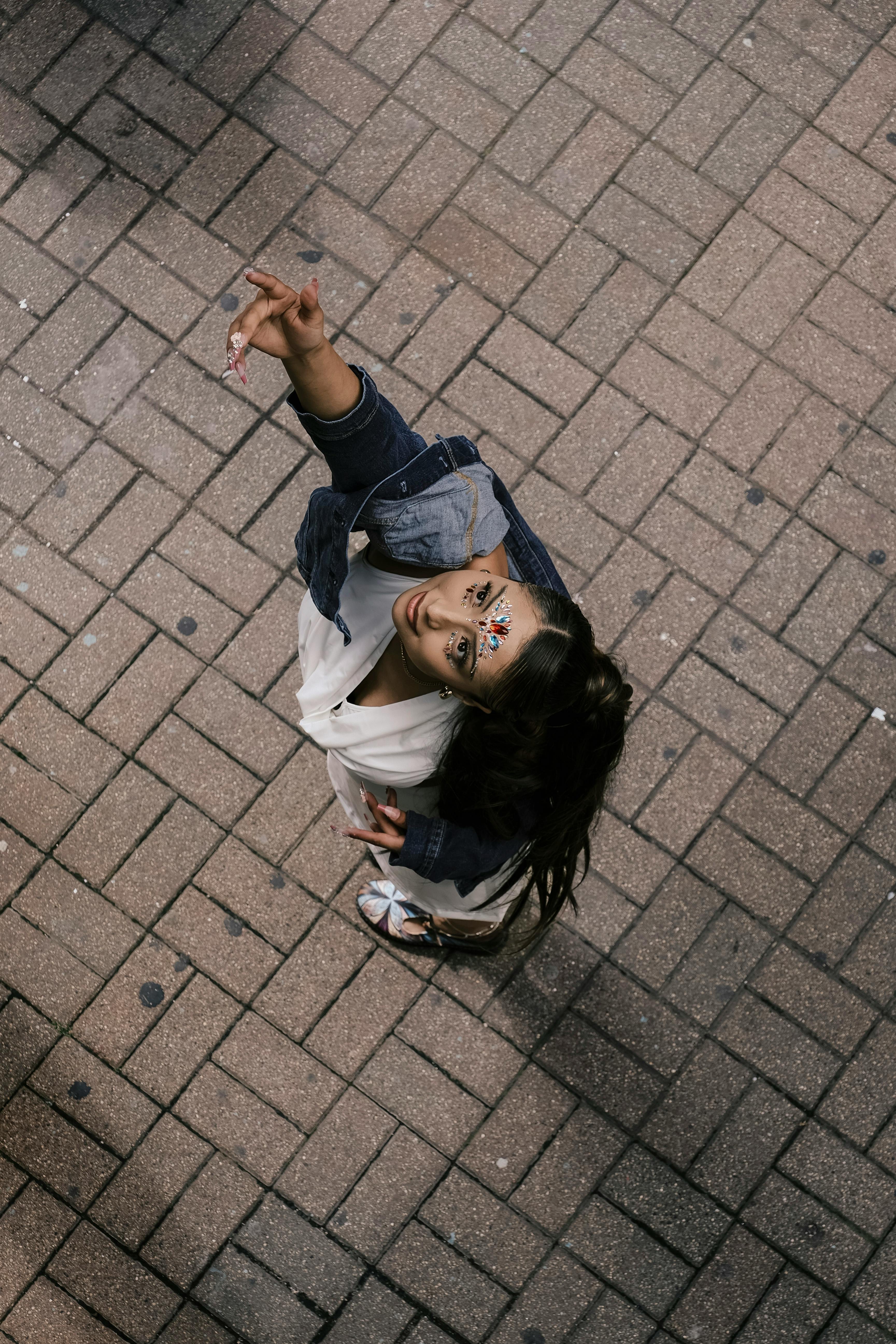 Top View of Brunette Woman Standing with Arm Raised · Free Stock Photo