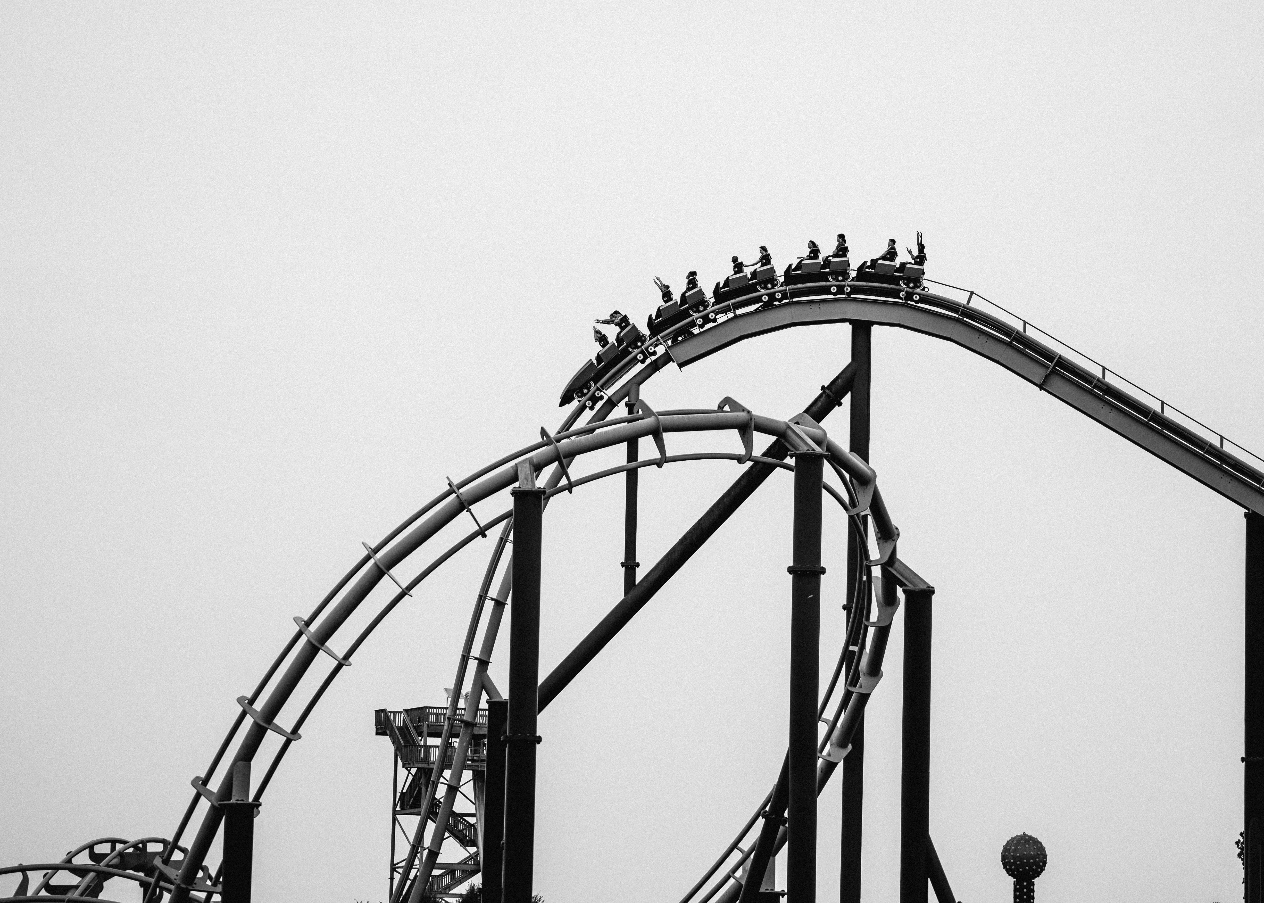 People Riding on a Roller Coaster in an Amusement Park · Free Stock Photo