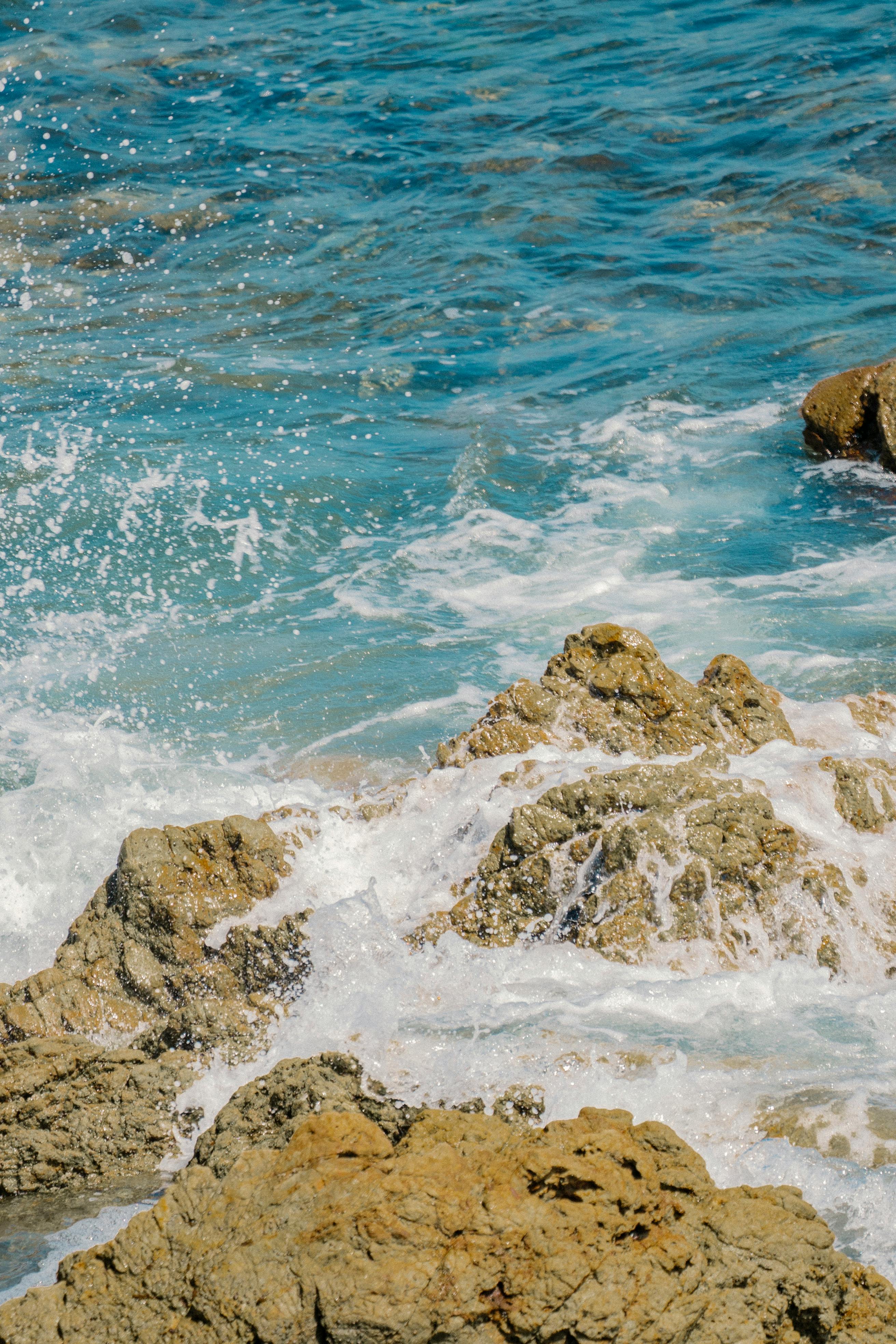 Waves Splashing Over Rocks in Water · Free Stock Photo