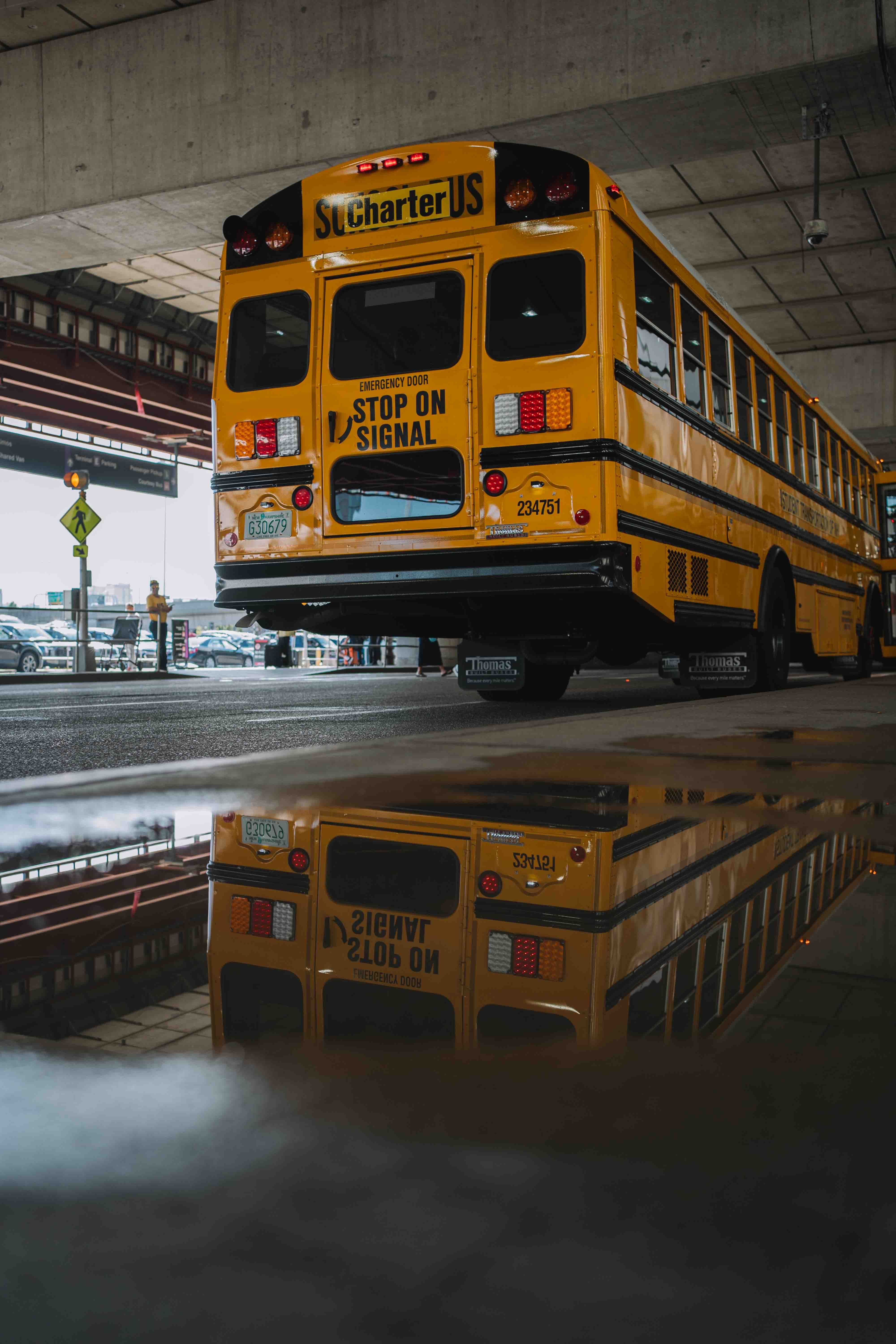 Yellow Bus Reflecting in Puddle · Free Stock Photo