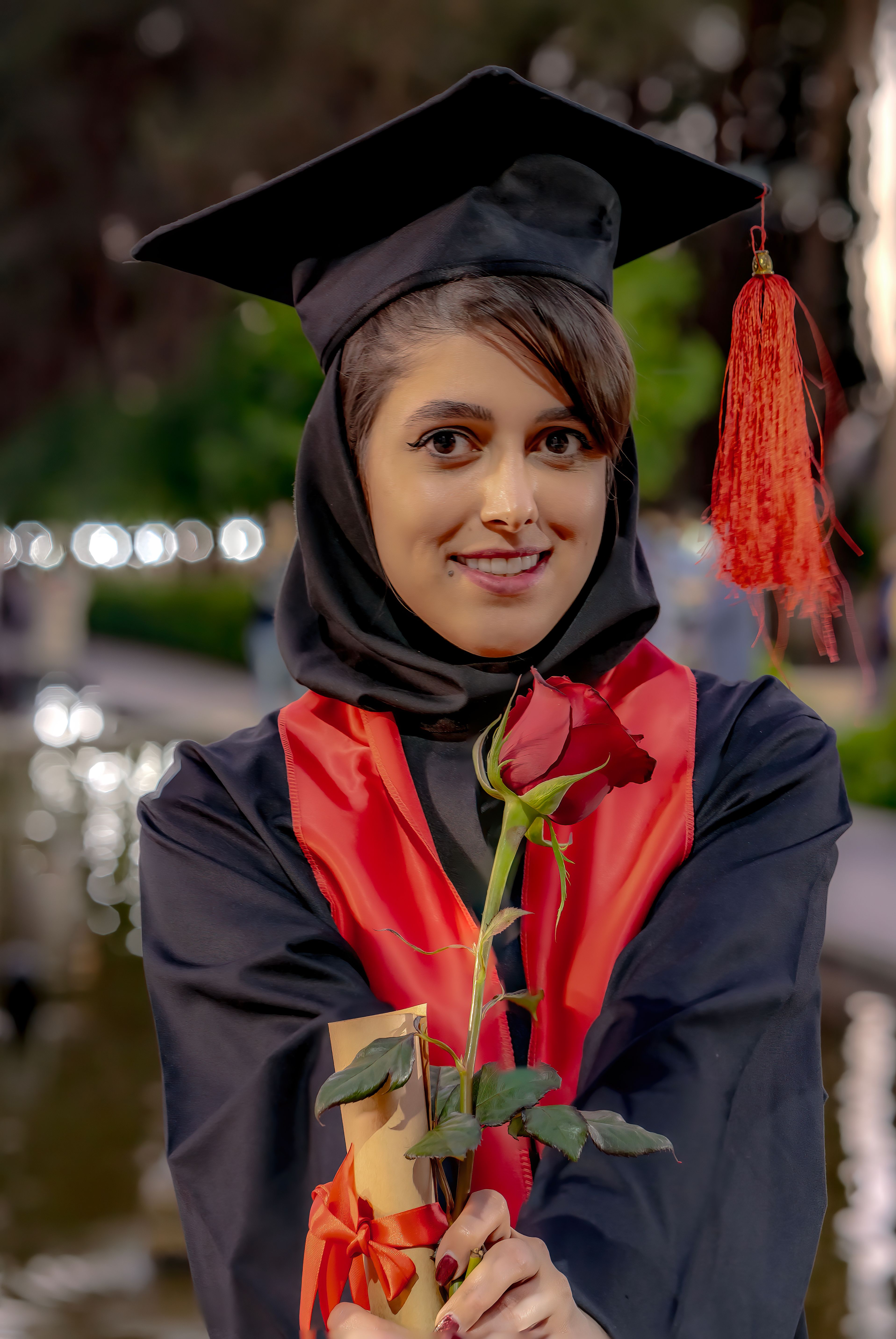 Woman During Graduation Day Holding a Red Rose · Free Stock Photo