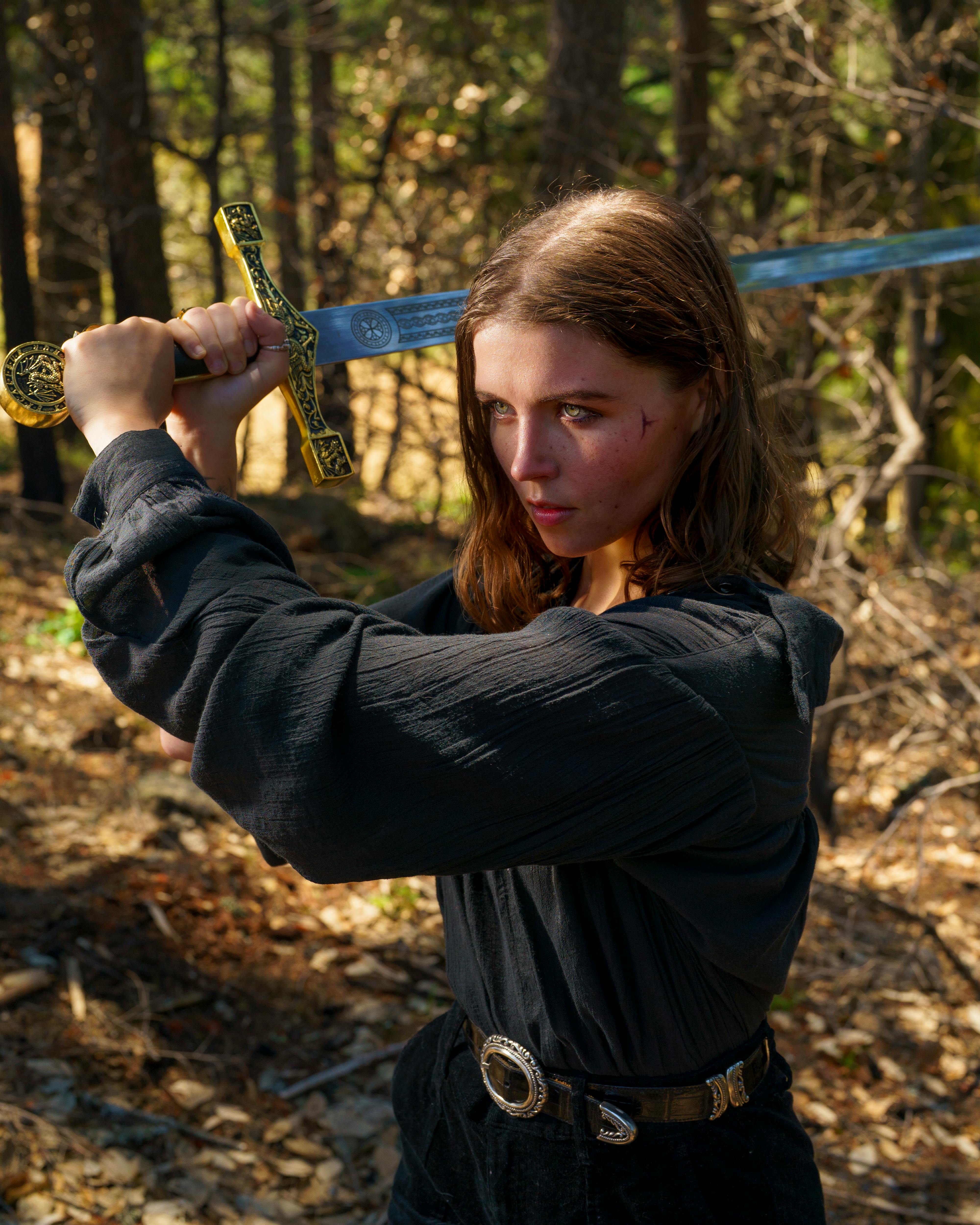 Beautiful Woman in Black Gown Posing with Sword · Free Stock Photo