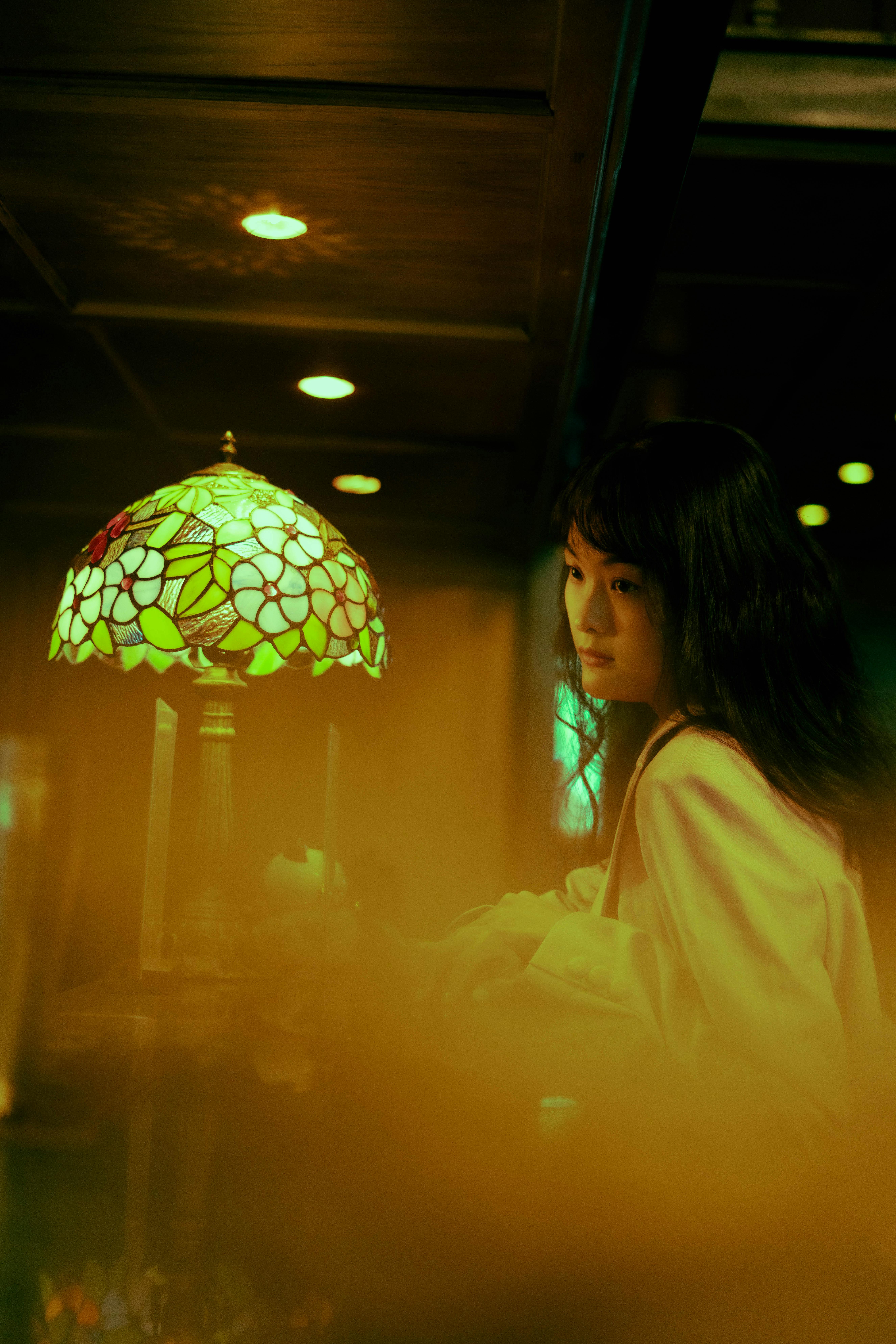 Woman Sitting near Lamp · Free Stock Photo