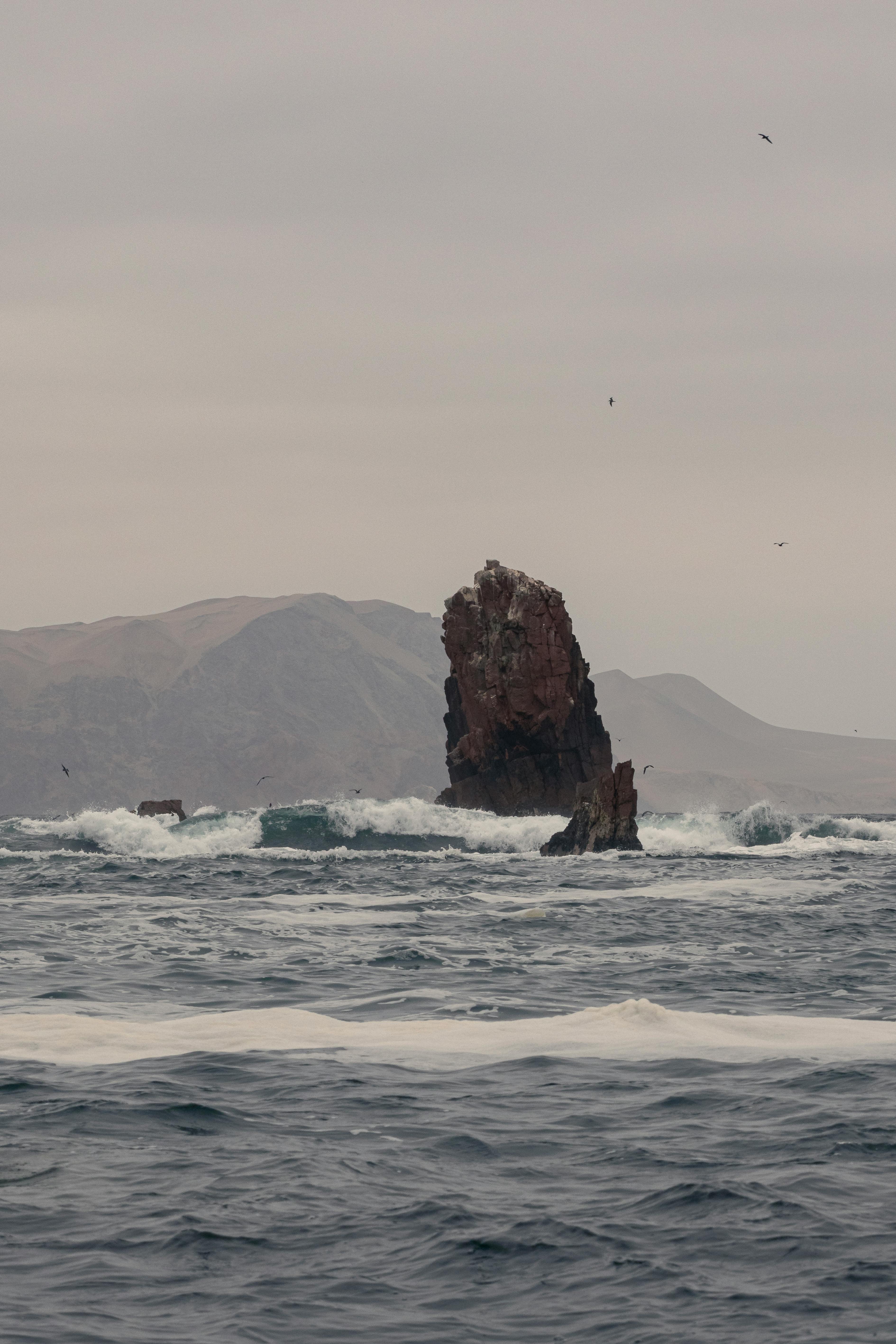 Rock in a Sea Among Waves · Free Stock Photo