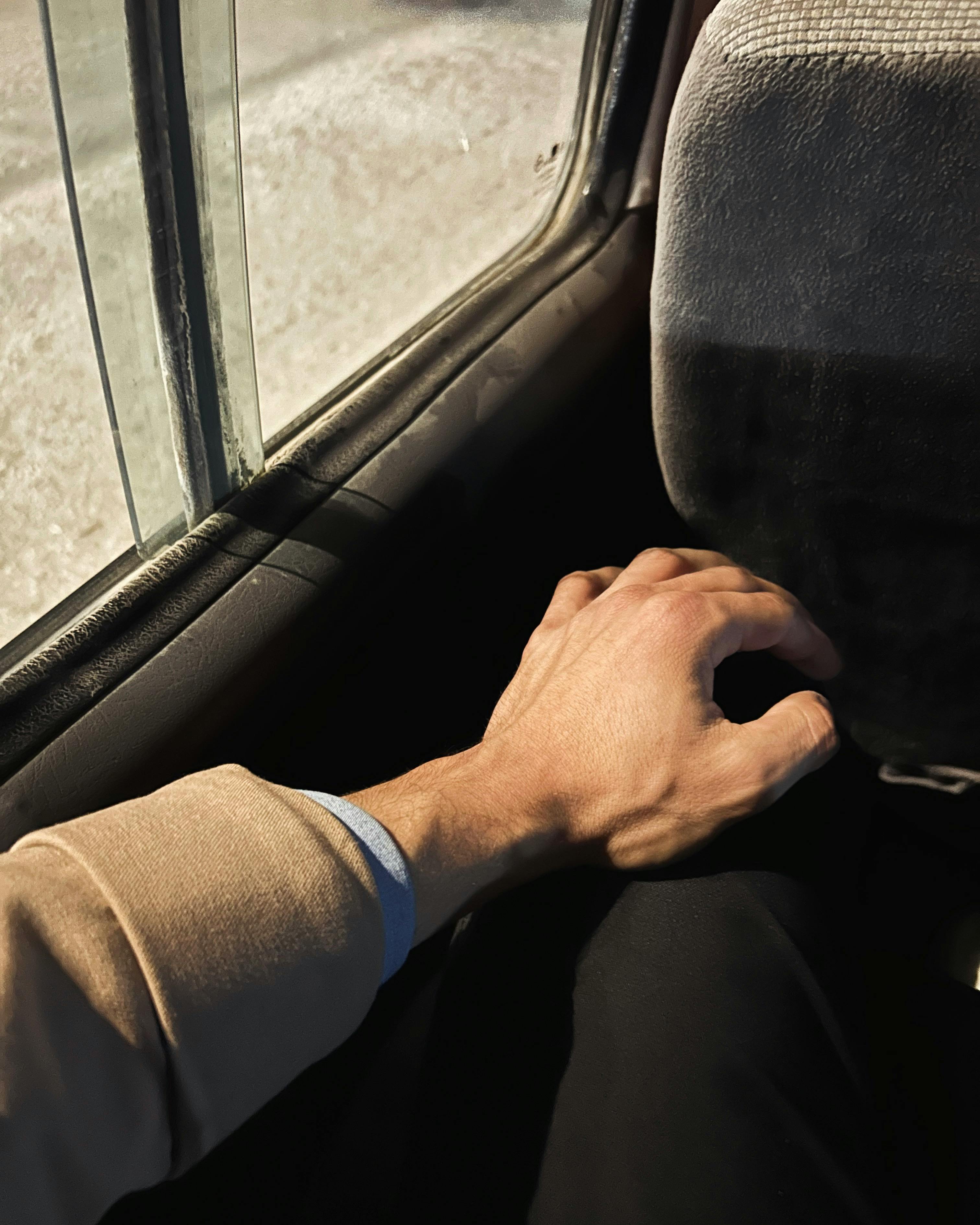 Hand of Man Sitting near Window · Free Stock Photo