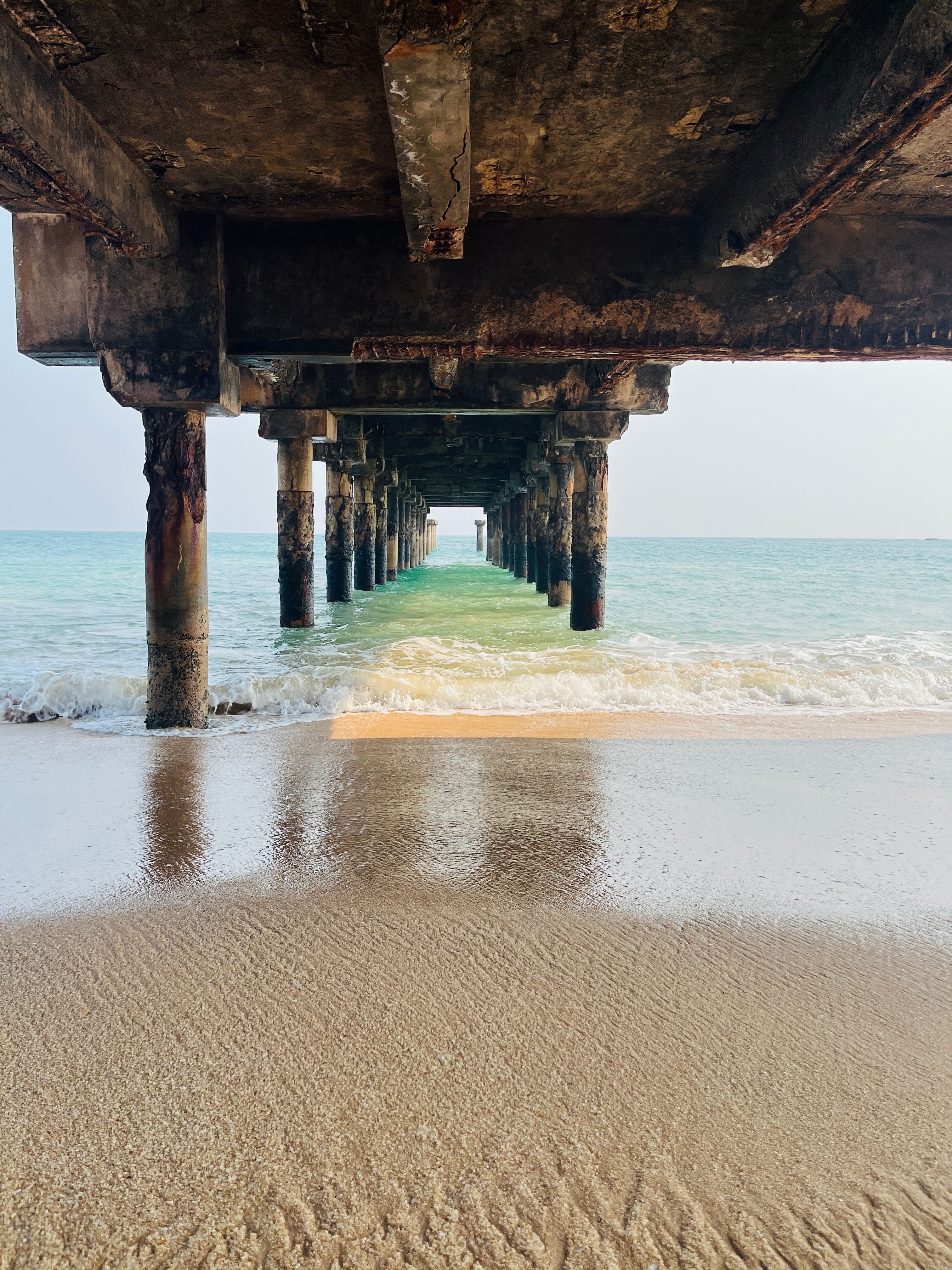 Beach Under the Concrete Pier · Free Stock Photo