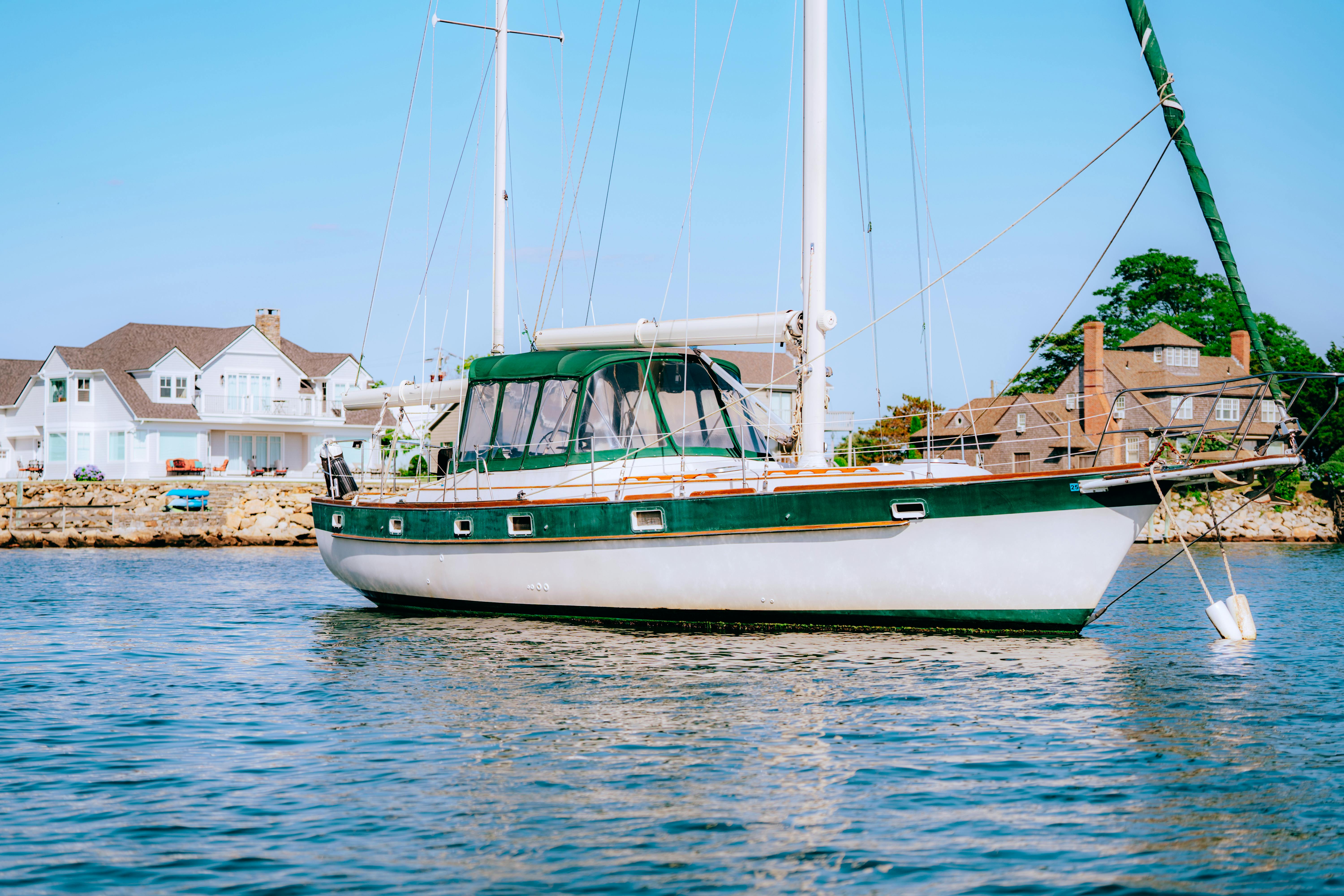 Sailboat with Furled Sails in Harbor · Free Stock Photo