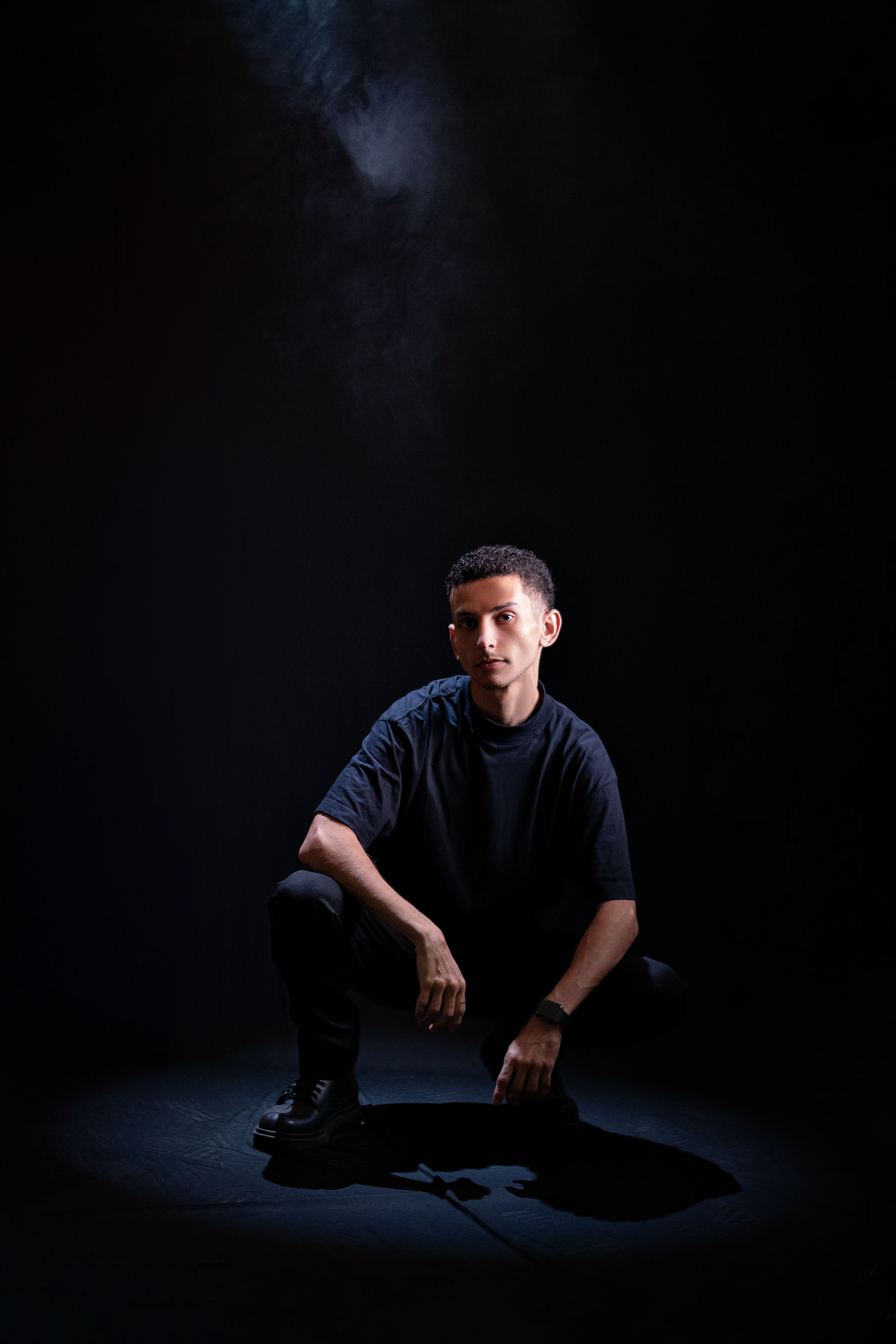 Man Crouching in Dark · Free Stock Photo