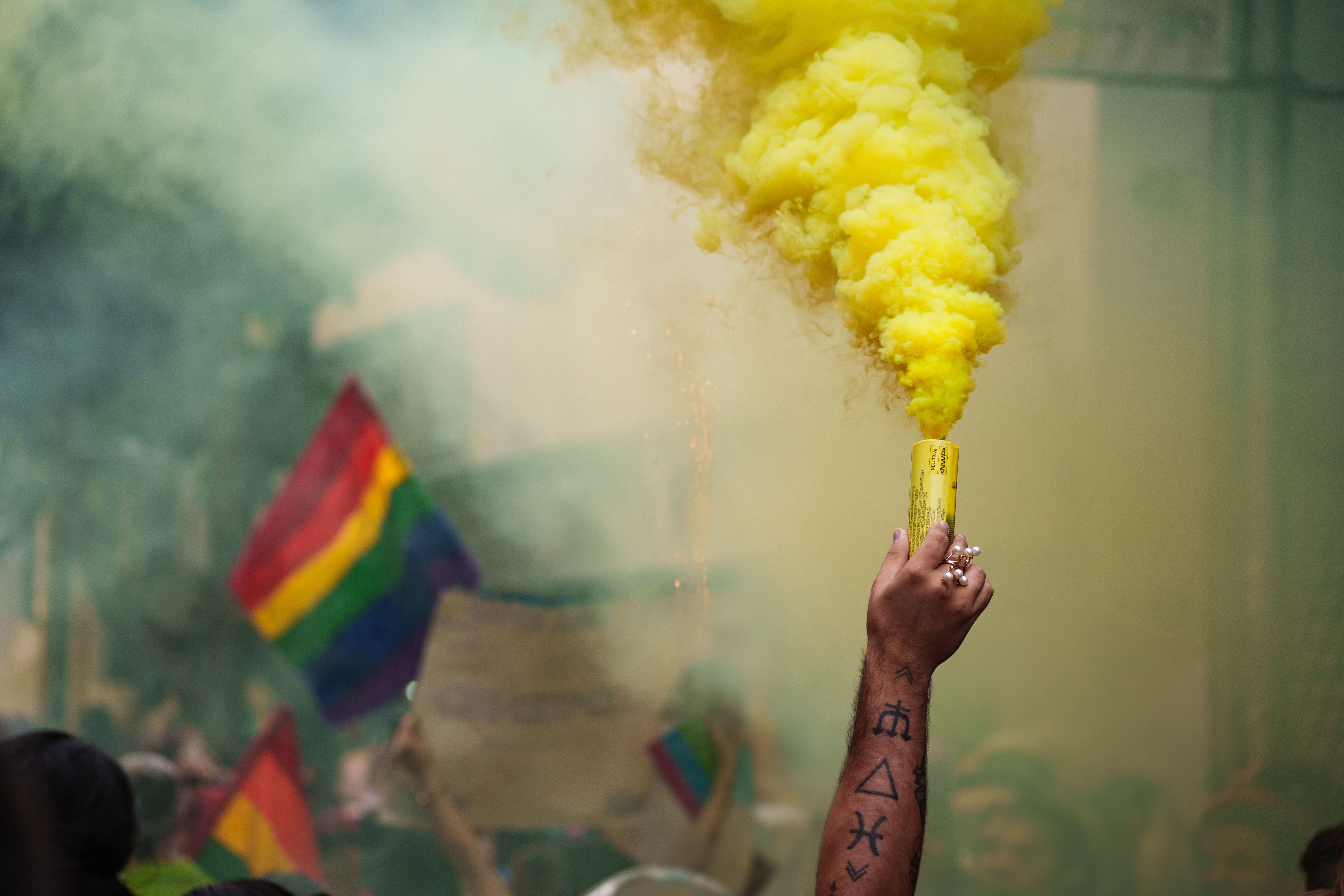 Close-up of the Hand Holding a Flare at a Gay Parade · Free Stock Photo