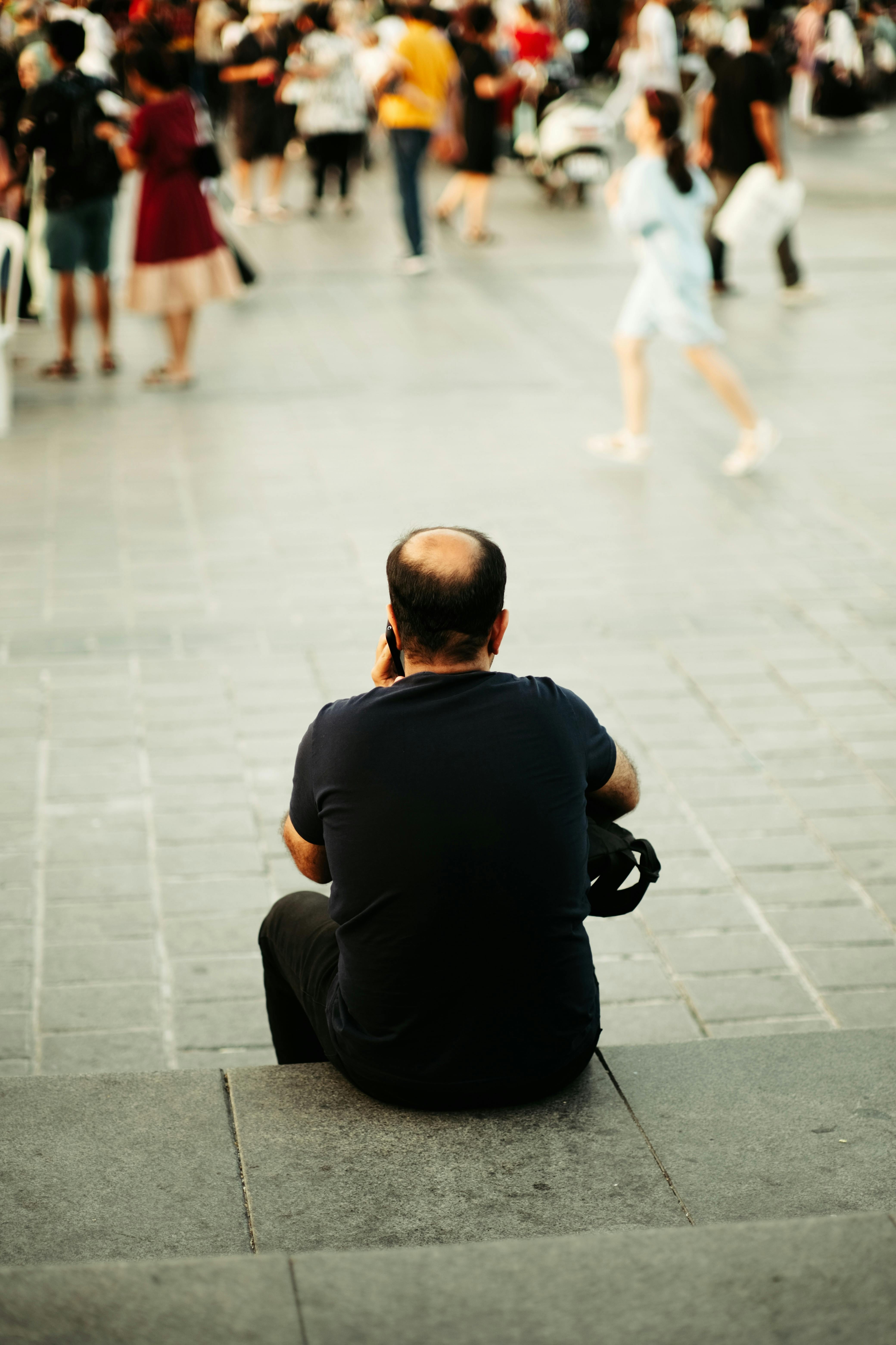Back View of a Man Sitting on the Steps · Free Stock Photo