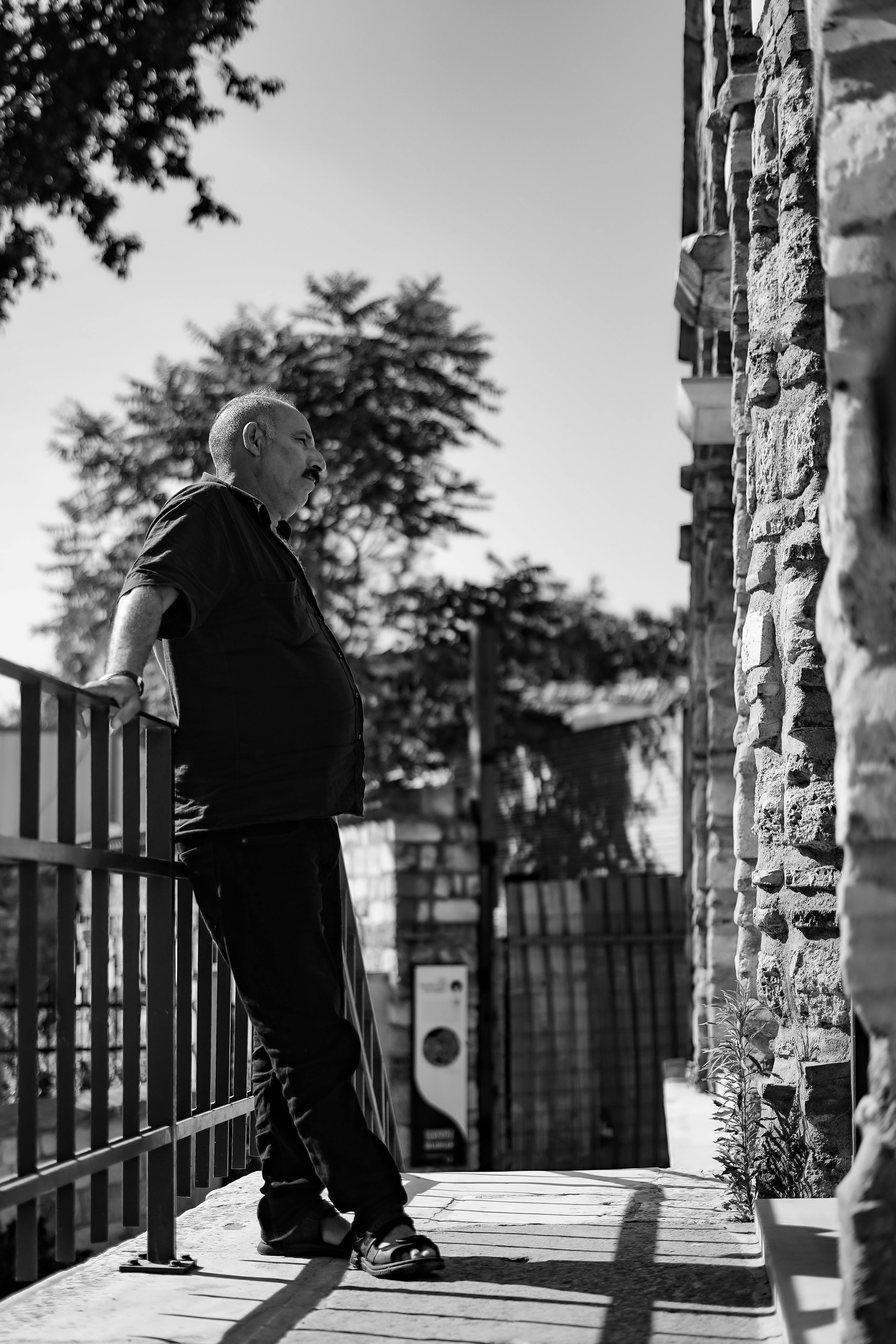 Standing Man Leaning on Railing · Free Stock Photo