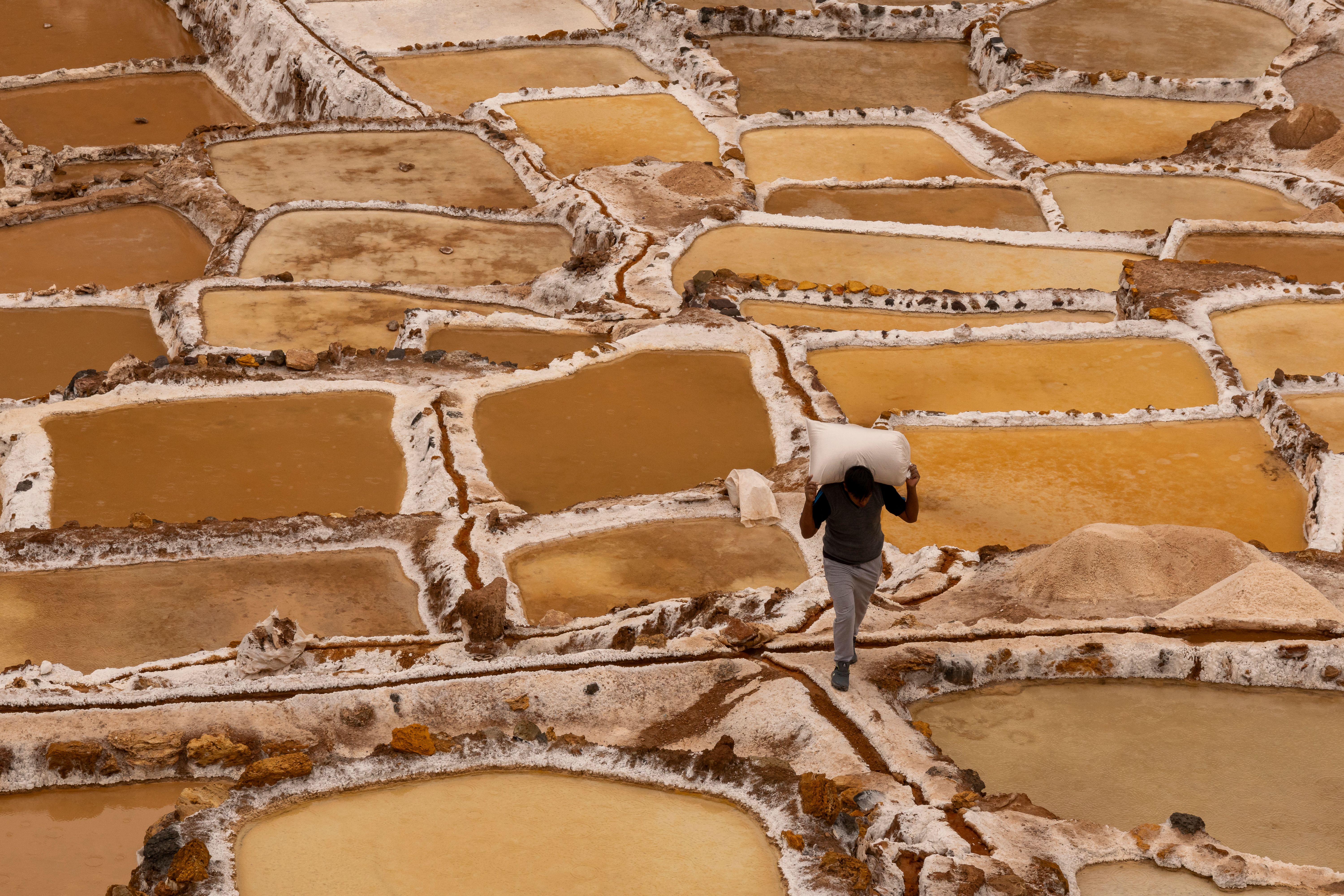 A person walking through a field of salt · Free Stock Photo