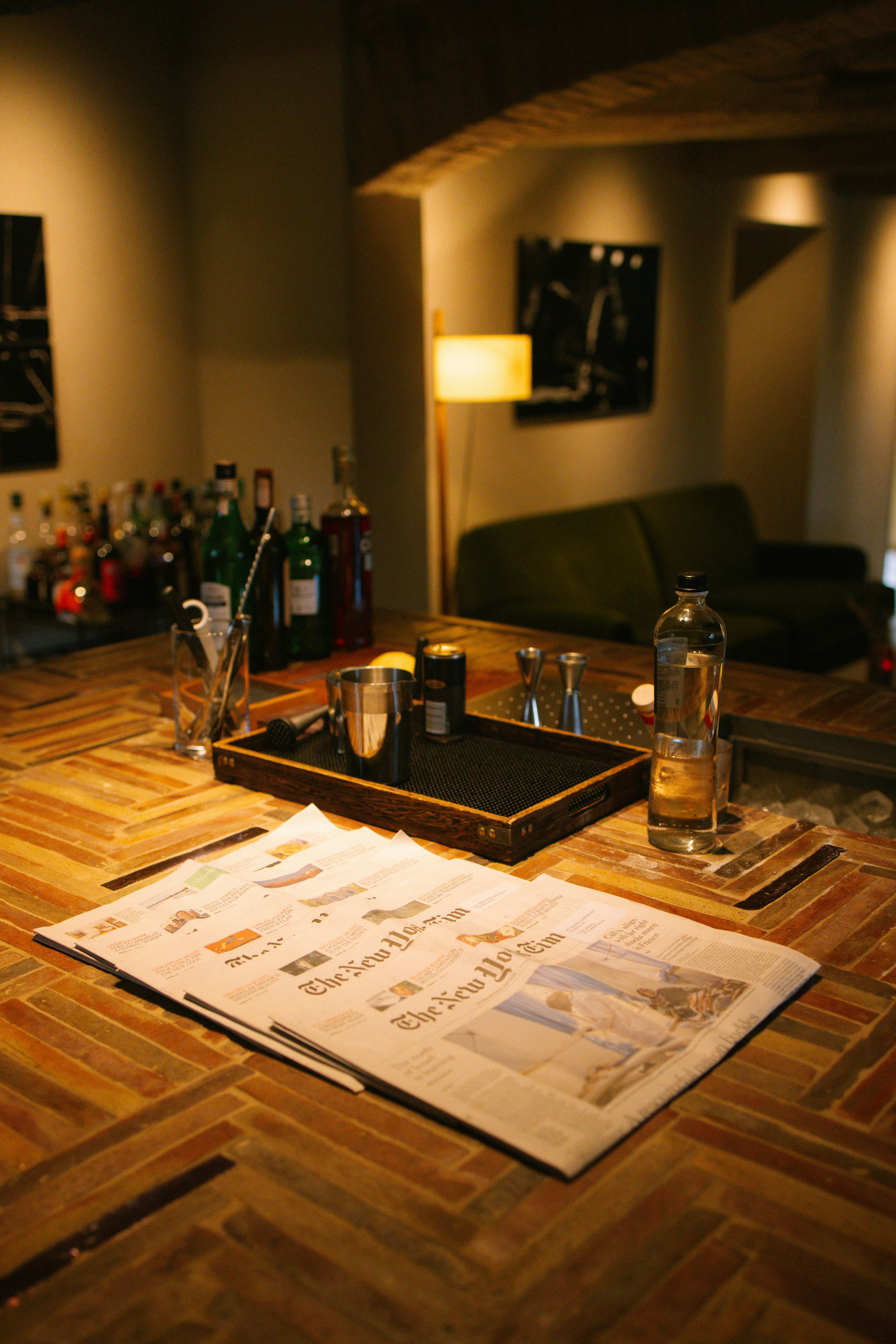 A bar with a table and a bottle of liquor · Free Stock Photo