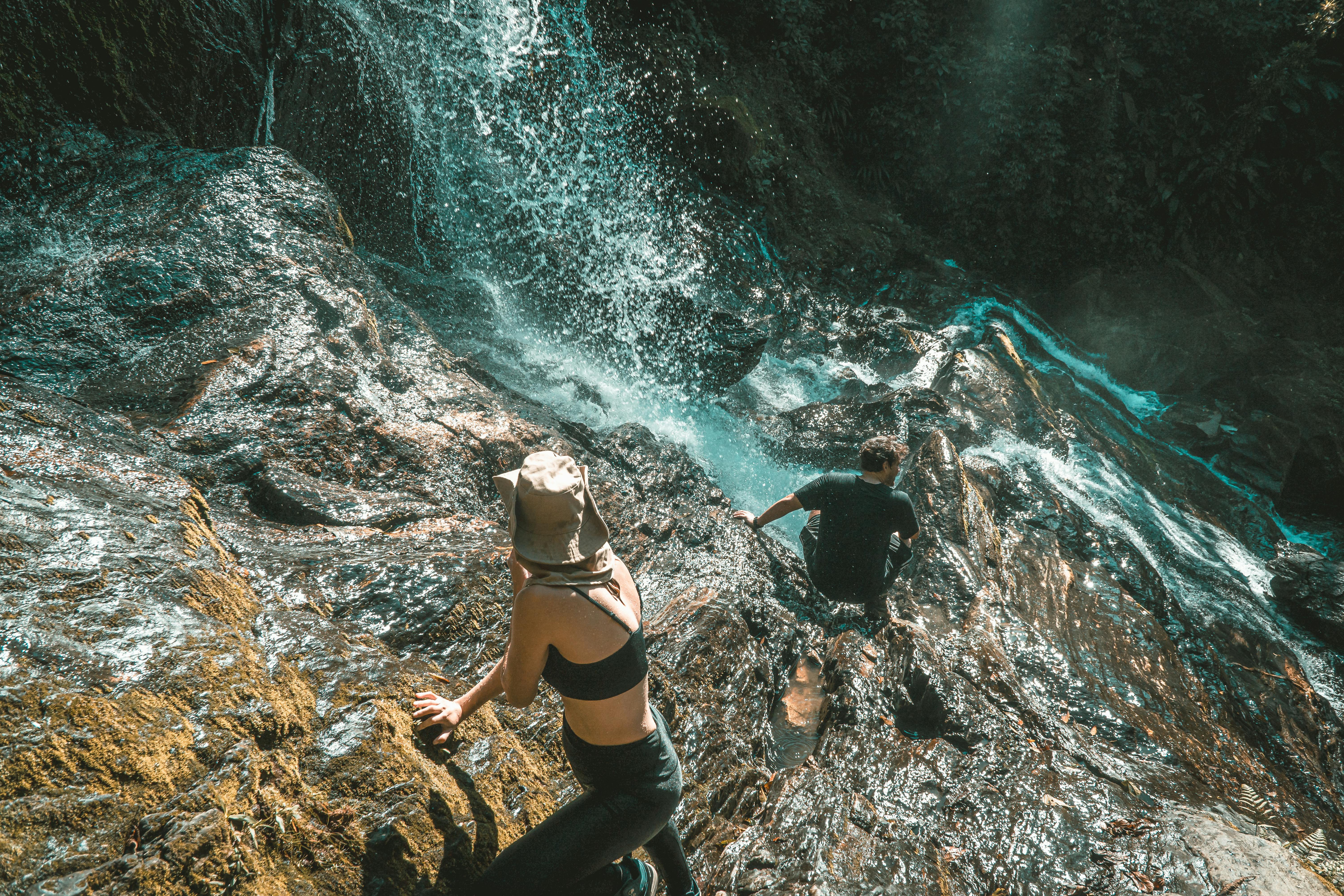 Person Walking Under Waterfalls · Free Stock Photo