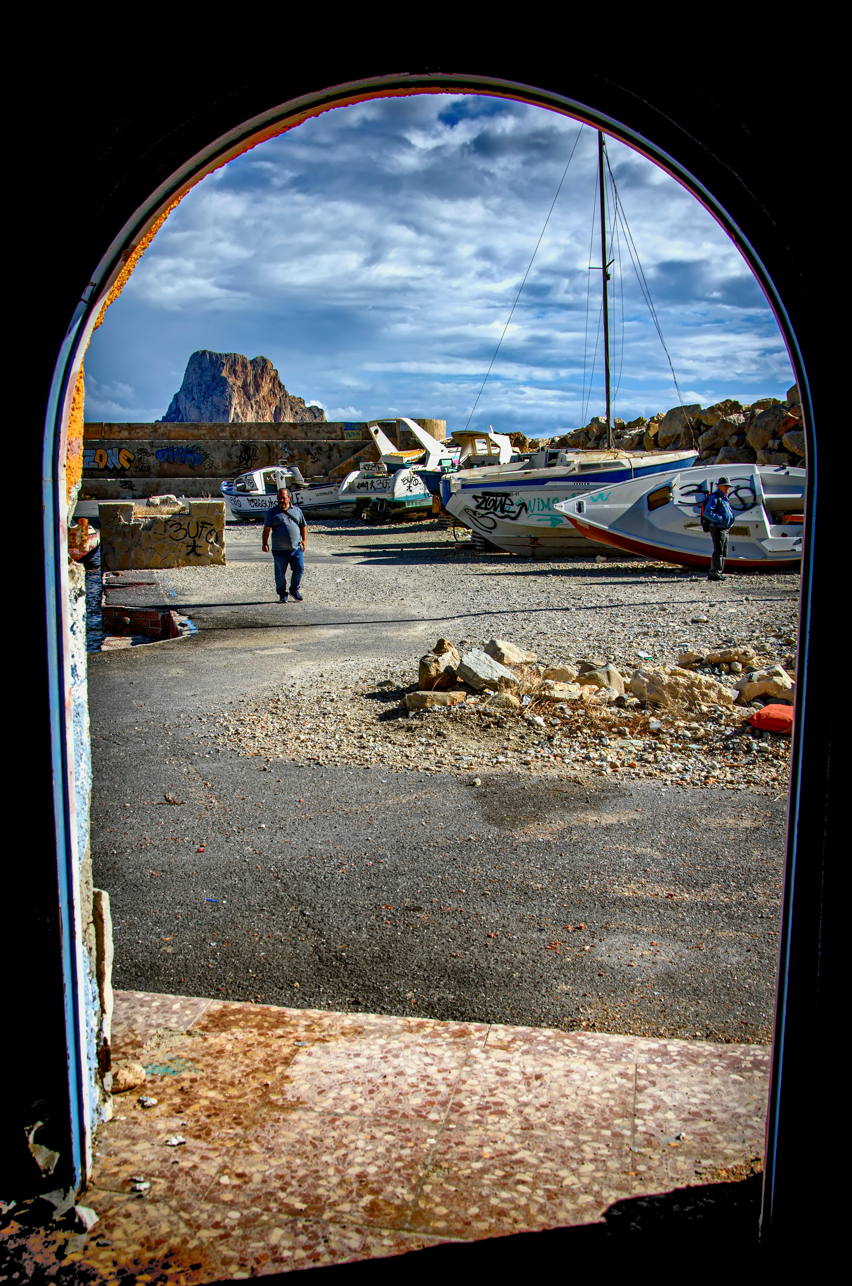 Walking Men and Sailboats on Pavement on Coast · Free Stock Photo