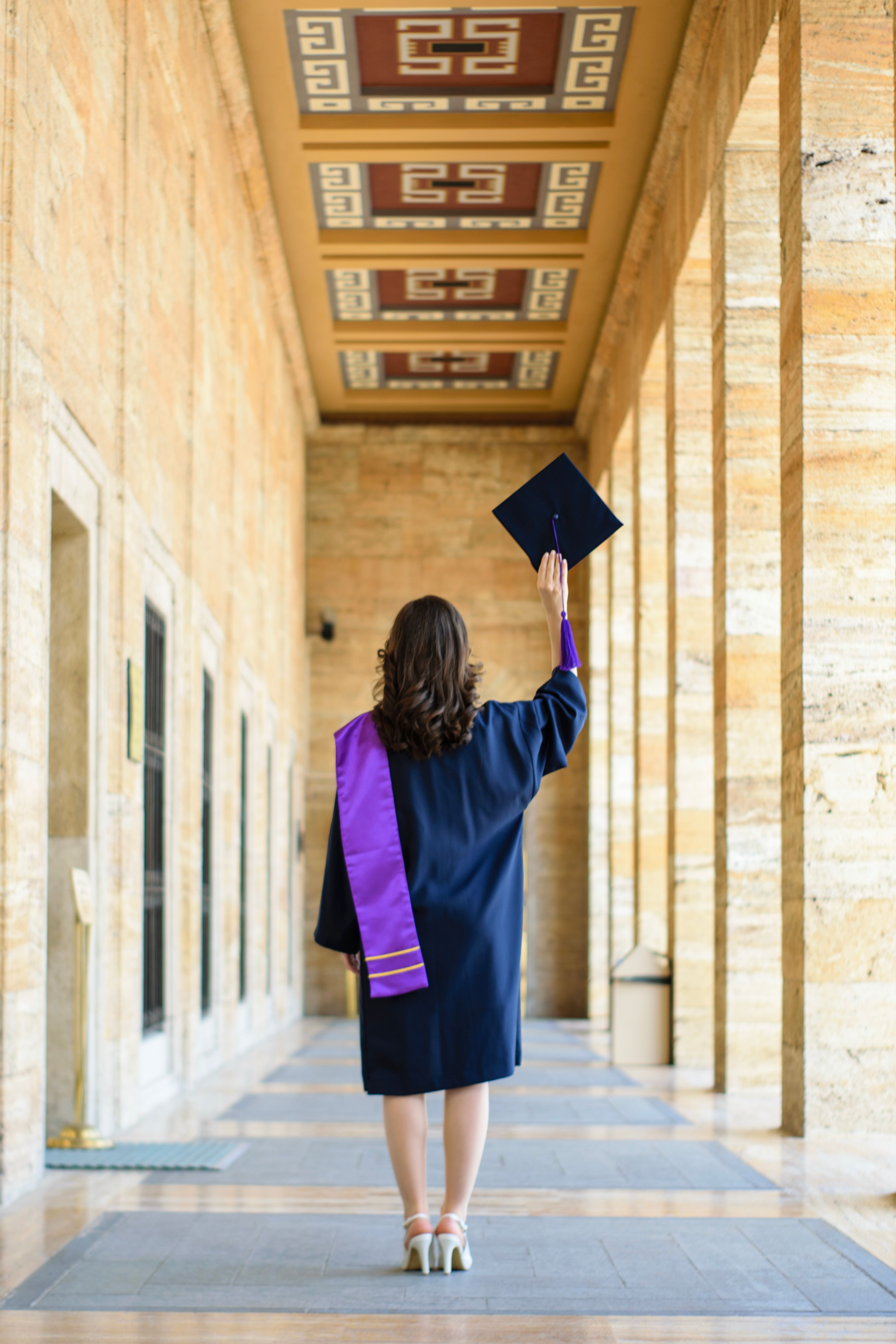 Man and Woman in Black Graduation Gown Walking on Hallway · Free Stock ...