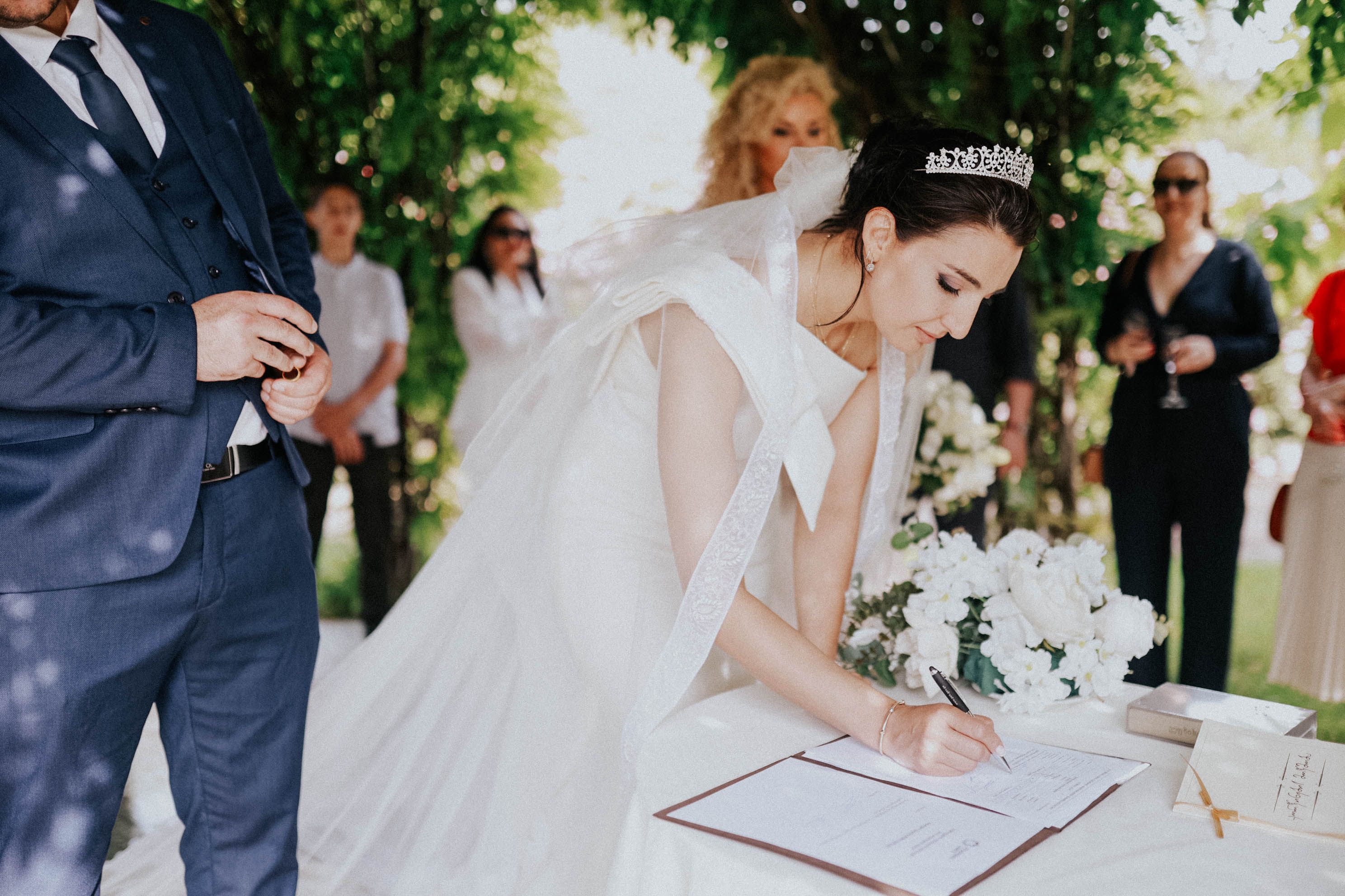 A Bride Signing the Marriage Certificate in the Garden · Free Stock Photo