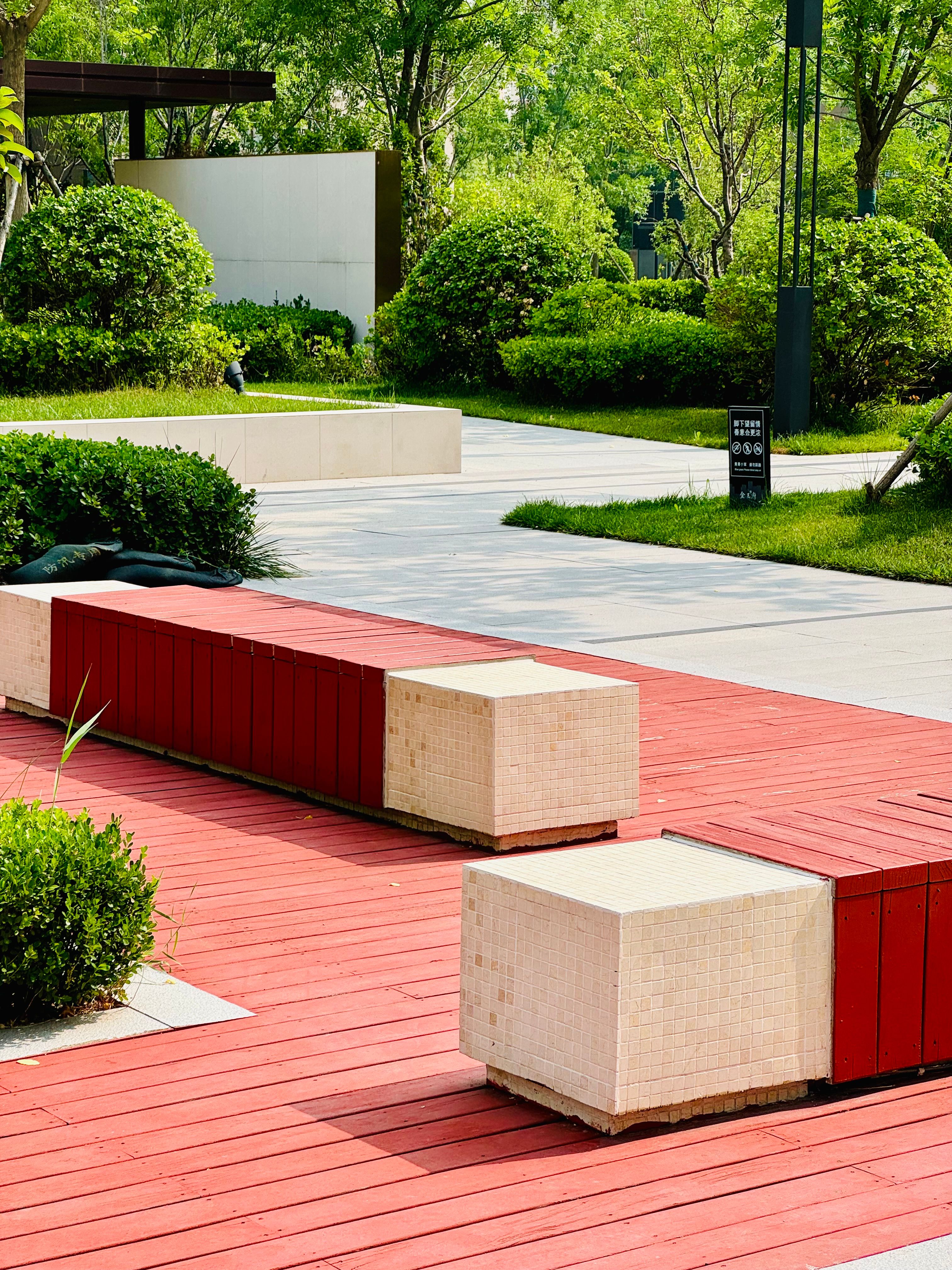 A red bench and two white benches in a park · Free Stock Photo
