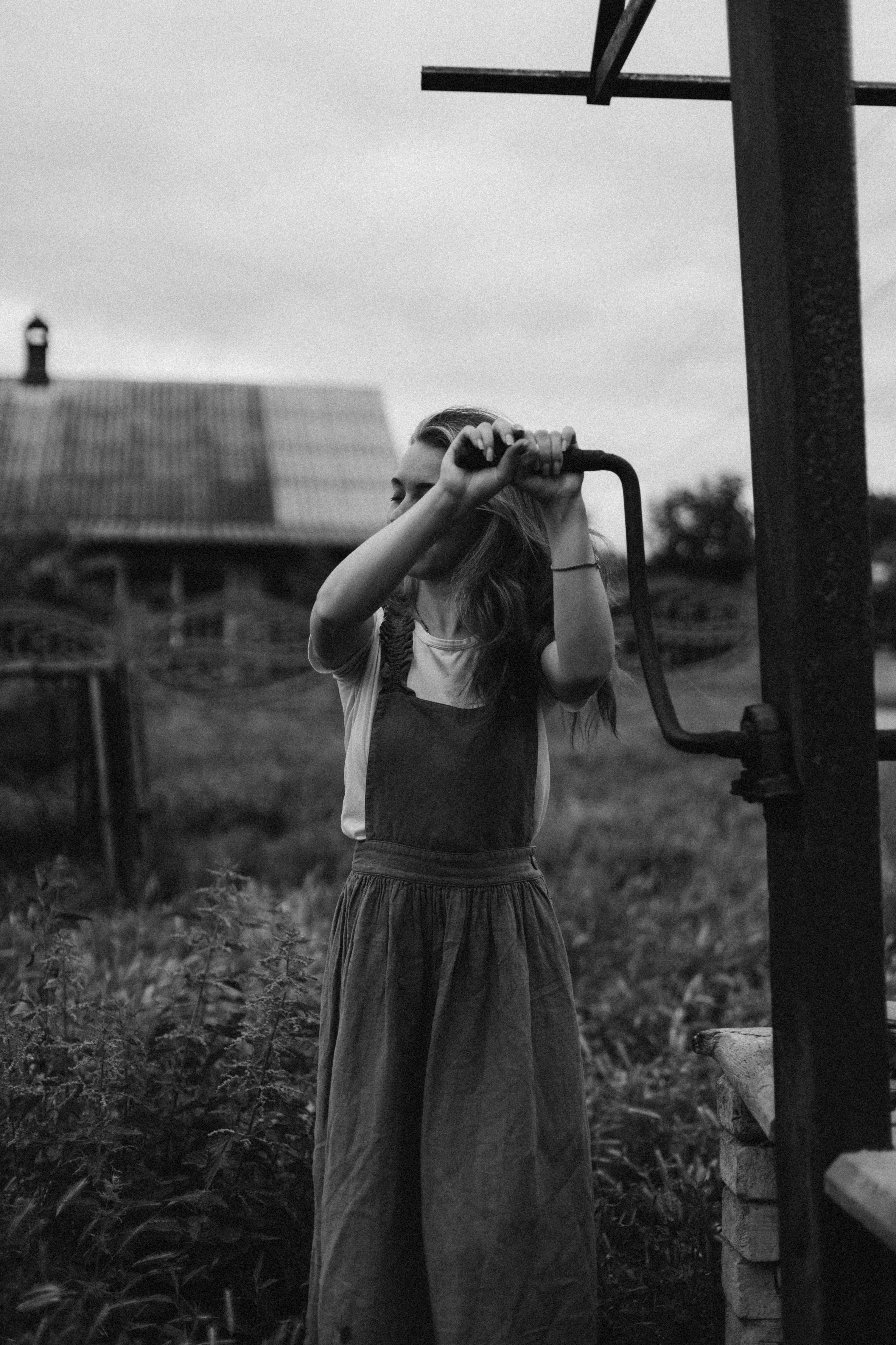 Woman in Dress Spinning Lever on Farm · Free Stock Photo