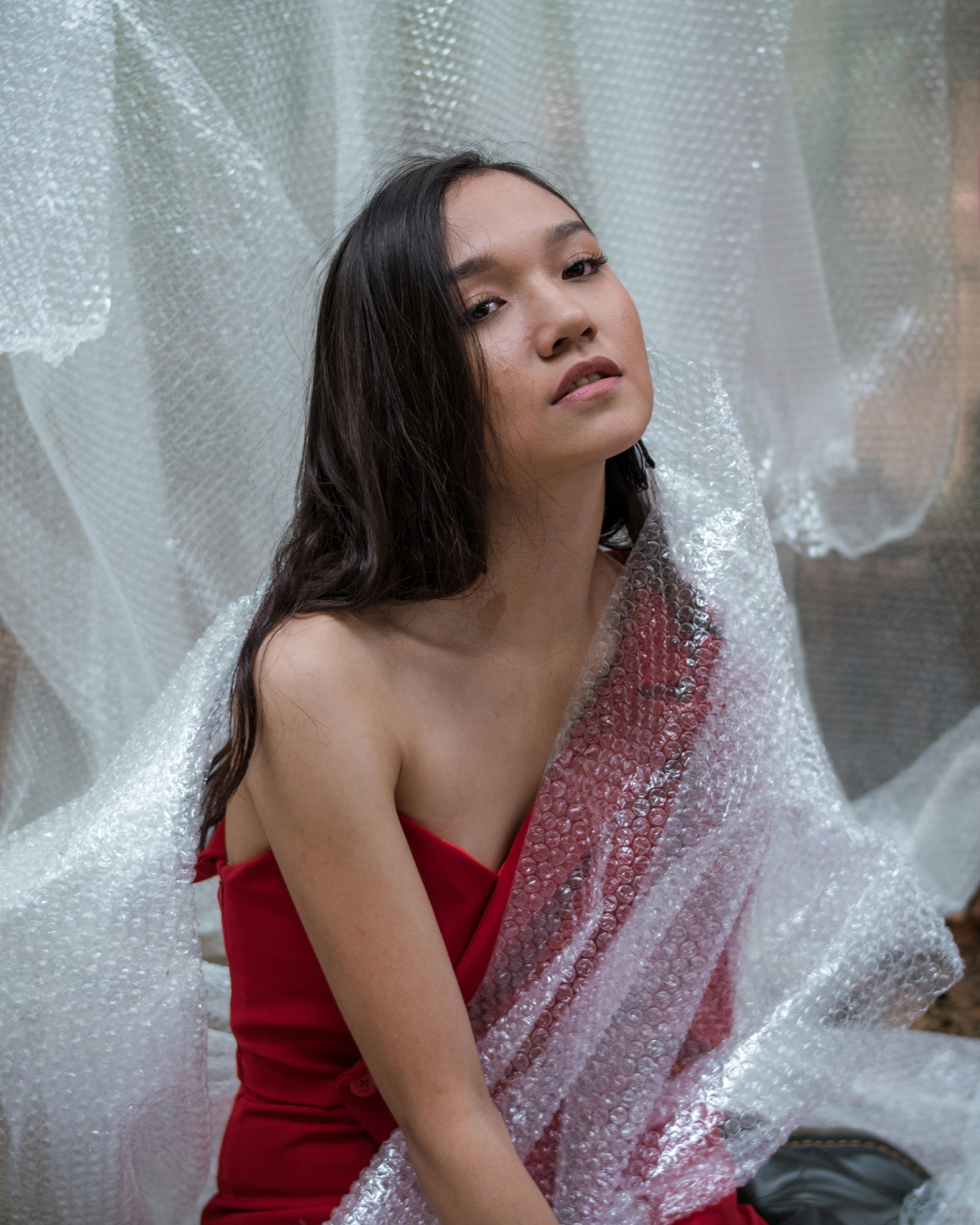 Woman in a Red Dress Wrapped in Bubble Foil · Free Stock Photo