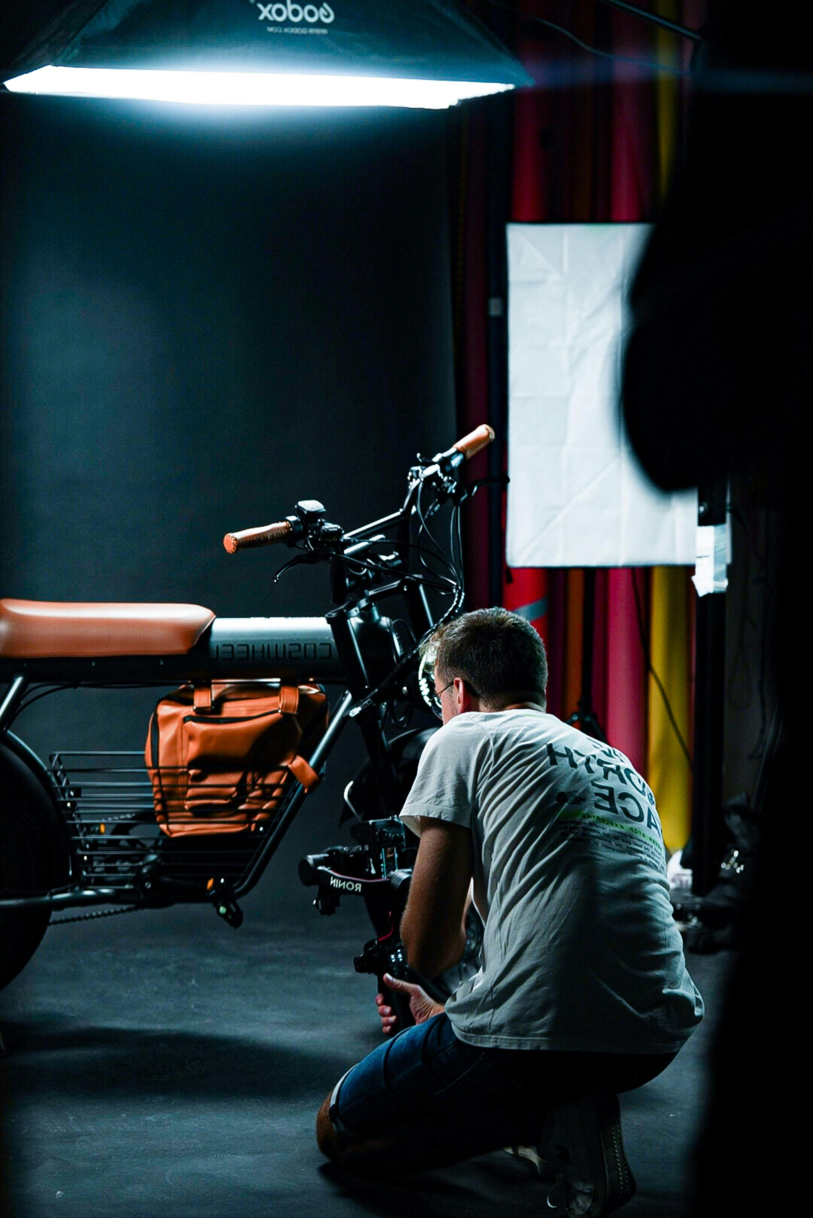 Man Filming E-Bike in Studio · Free Stock Photo