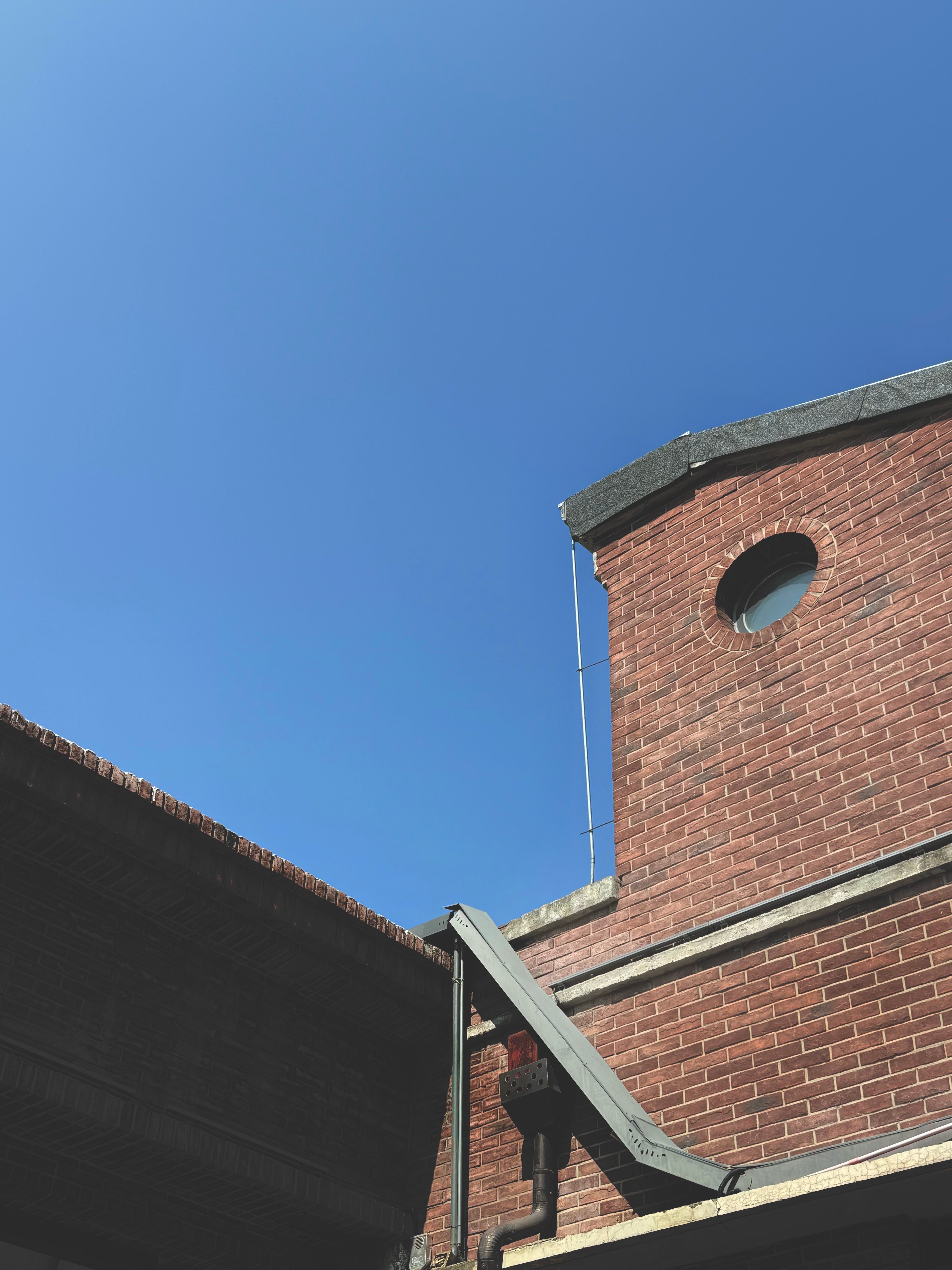 Clear Sky over a Brick Building · Free Stock Photo