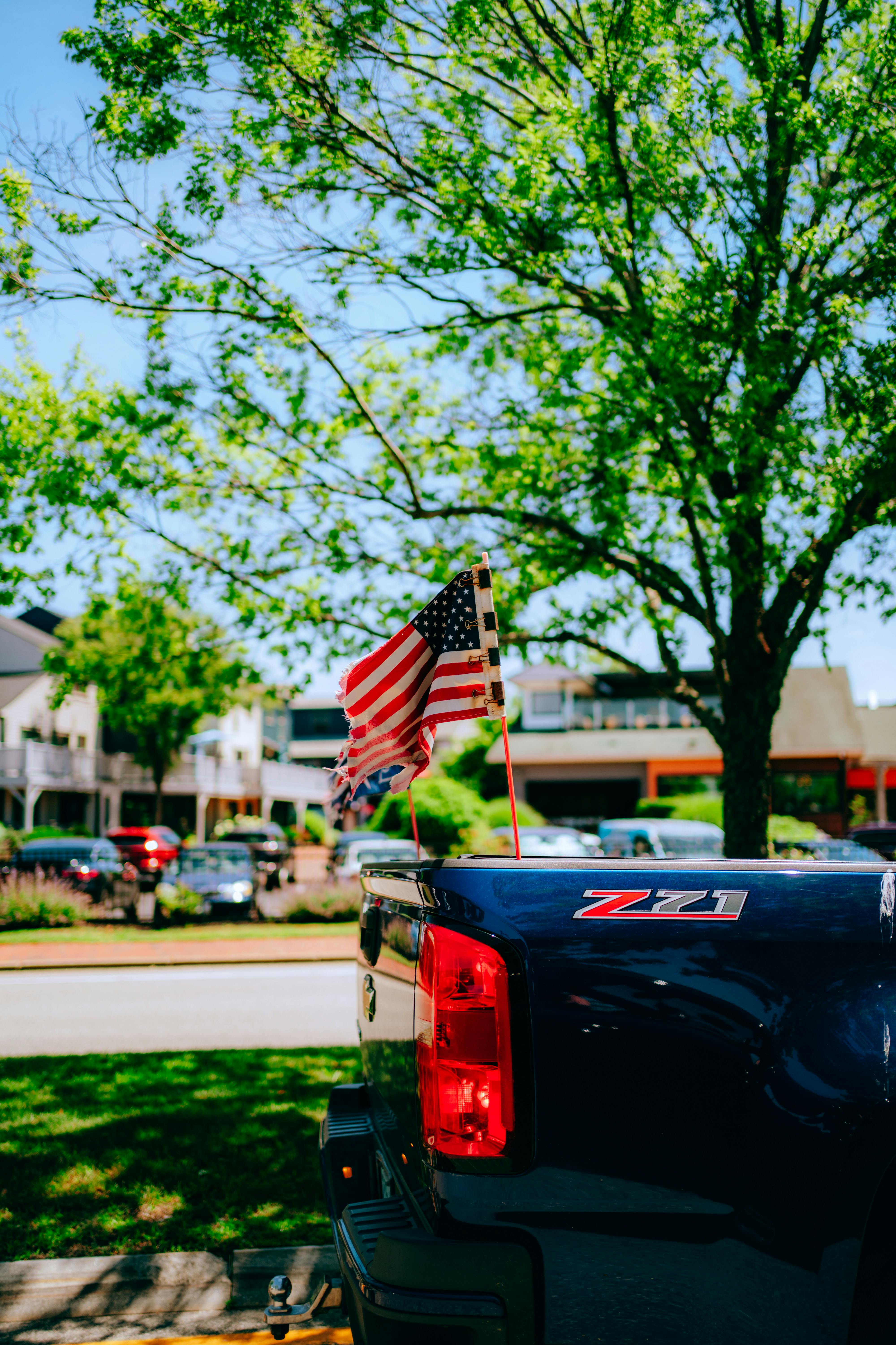 USA Flag Stick on Trunk of Pick-Up Car · Free Stock Photo